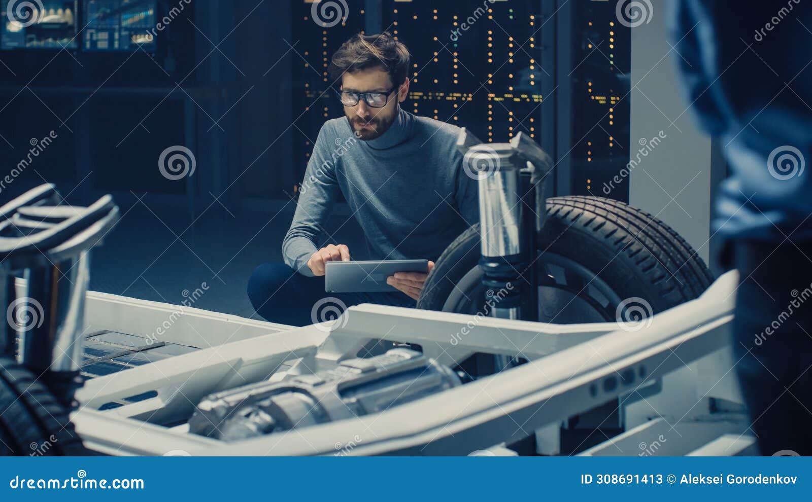 Automobile Design Engineer Sitting beside Hybrid Electric Car Chassis ...
