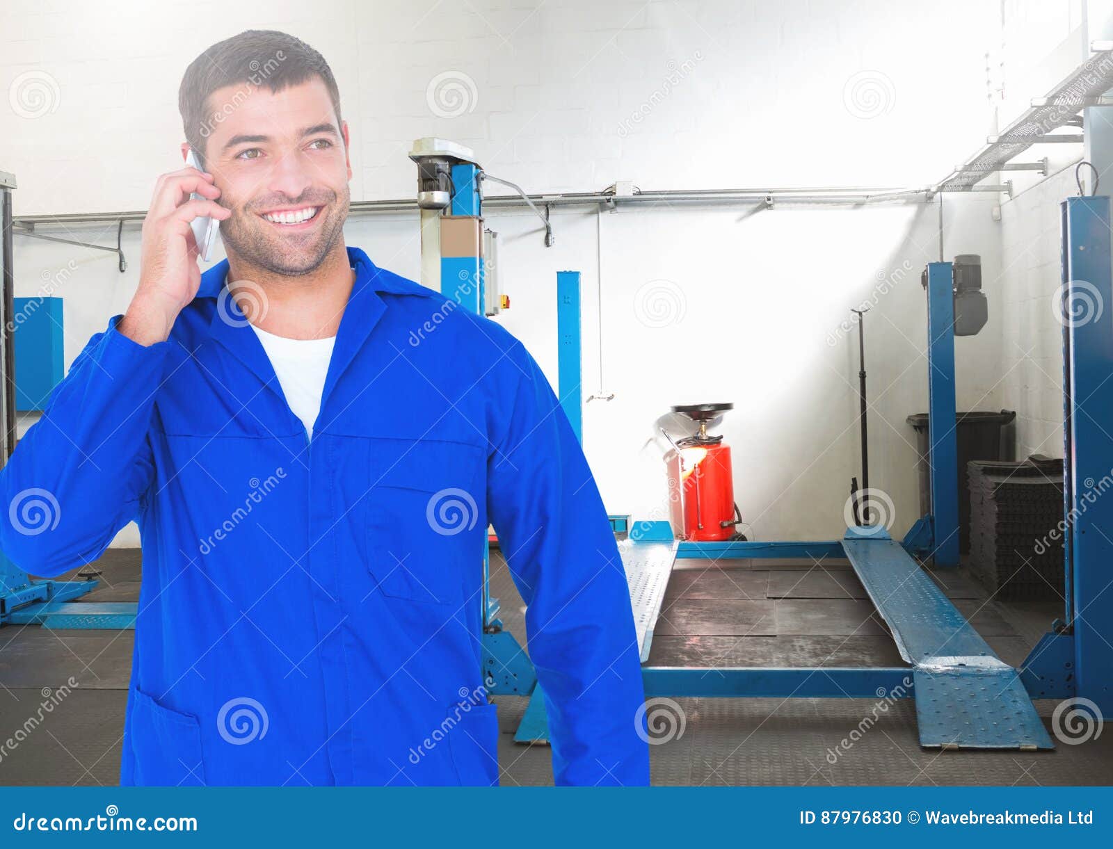 Automobile Mechanic Talking on Mobile Phone in Workshop Stock Photo ...
