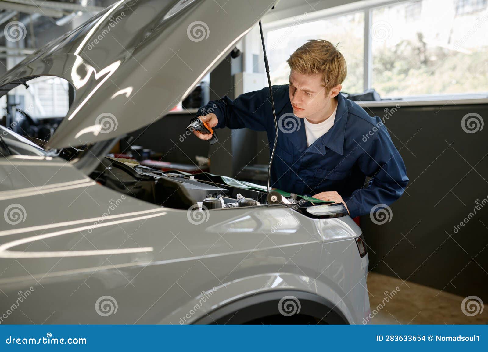 Automobile Technician Making Manual Diagnostics Checkup of Engine for ...
