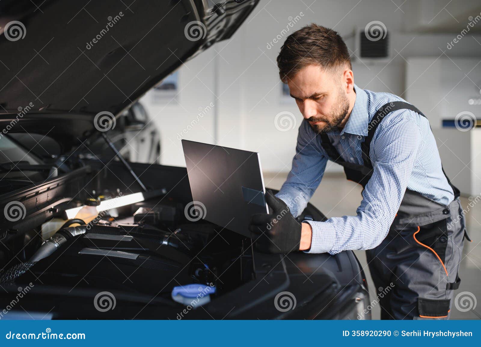 Automotive Mechanic Running Diagnostics Software on Computer. Mechanic ...