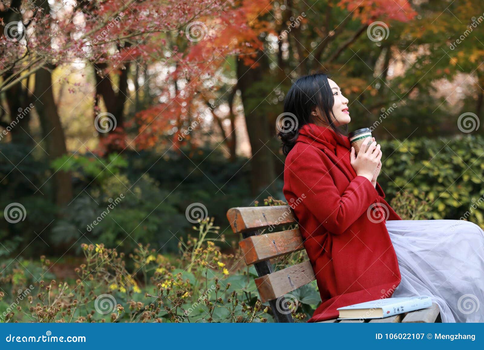 Young Asian Sensual Woman Reading A Book In Romantic Autumn Scenery