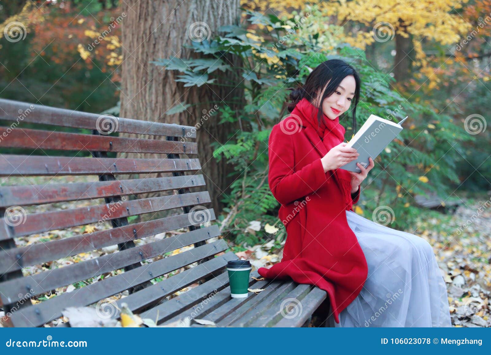 Young Asian Sensual Woman Reading A Book Sit Bench In Romantic Autumn