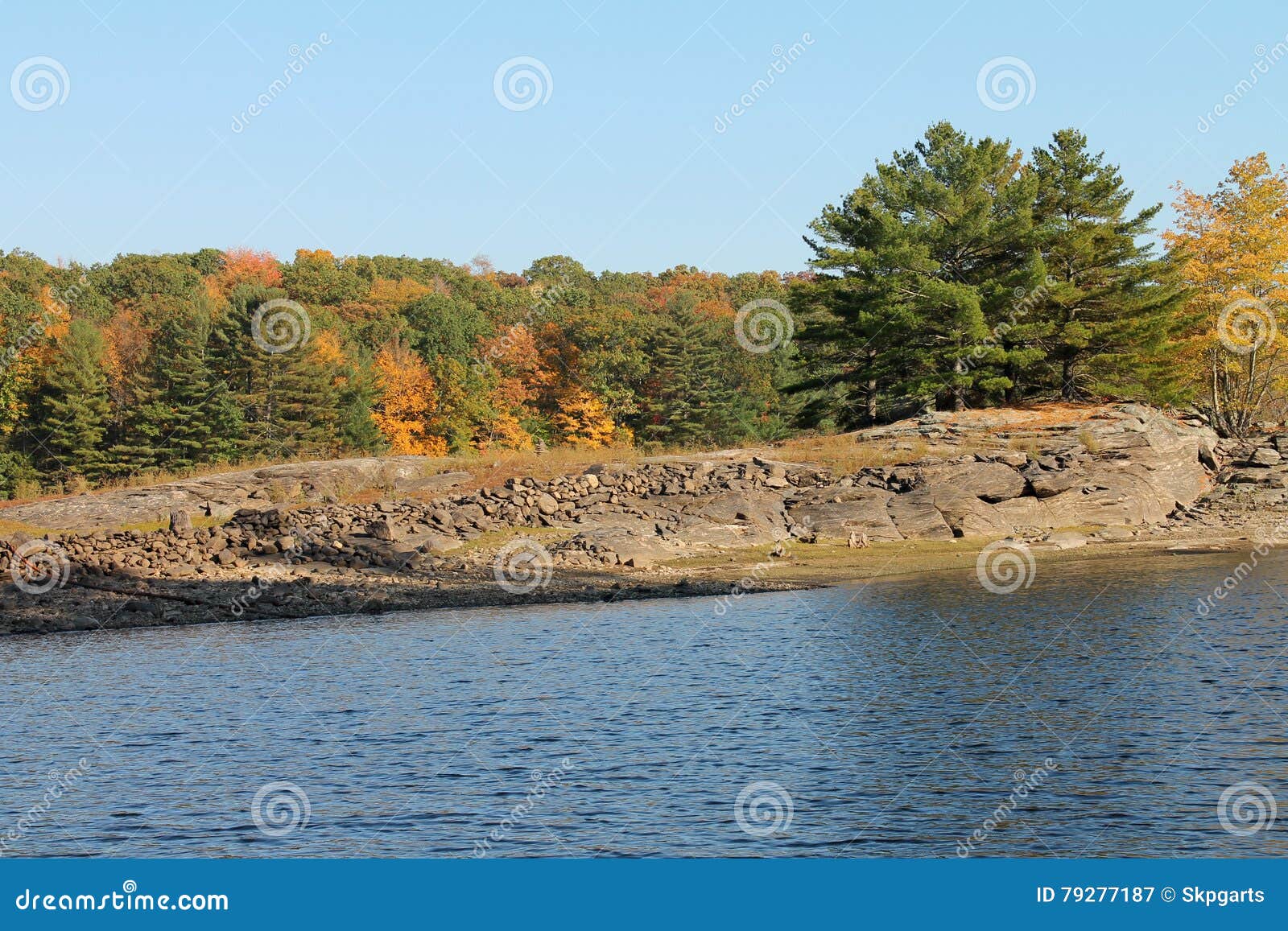 Autumn Trees and Rock Ledge Lake Stock Image - Image of rock, shore ...