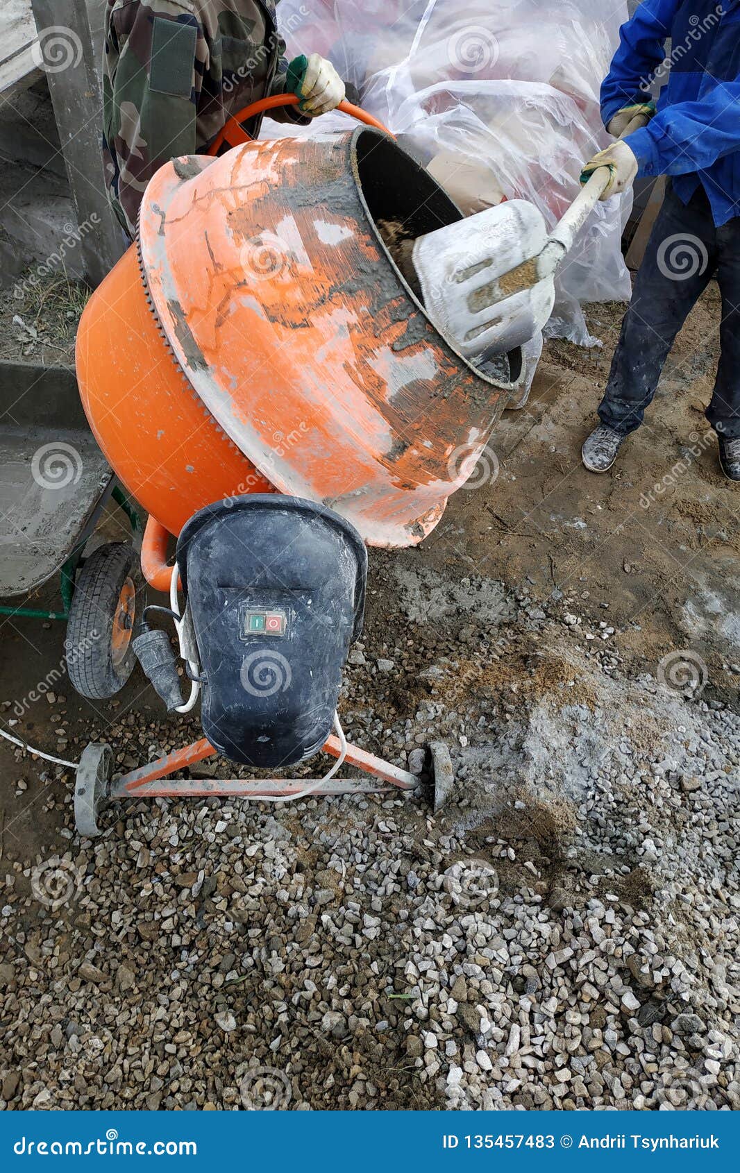 Auxiliary Worker Develops a Cement Mortar in a Concrete Mixer at the ...