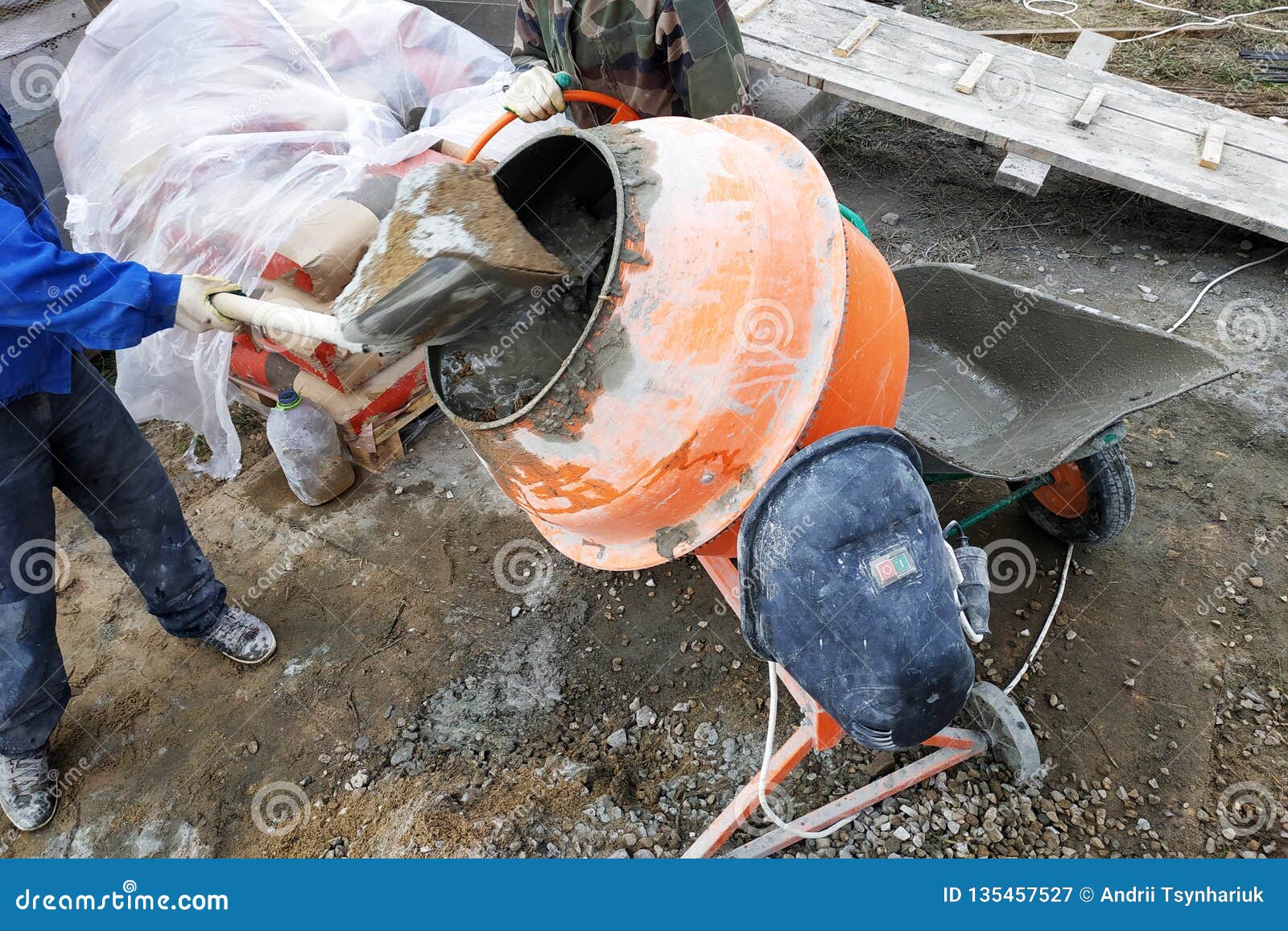 Auxiliary Worker Develops a Cement Mortar in a Concrete Mixer at the ...