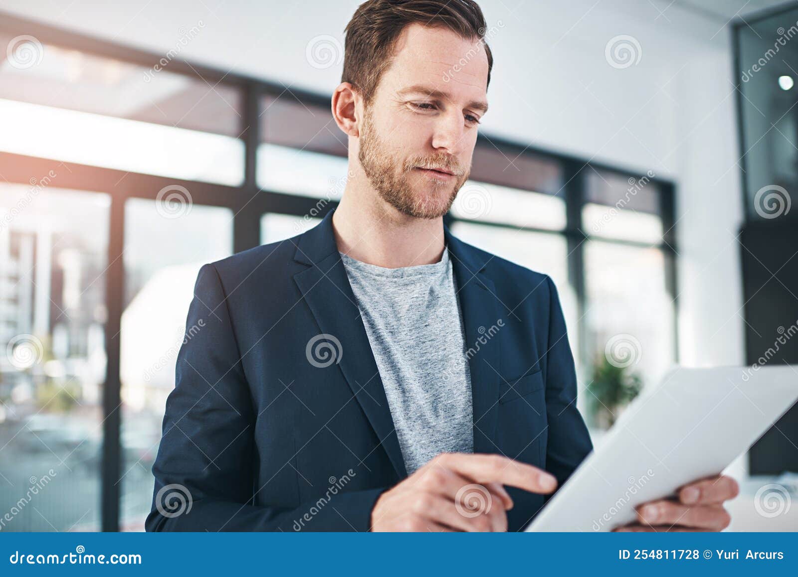 An Average Day in the Office. a Successful Businessman Using His Tablet ...