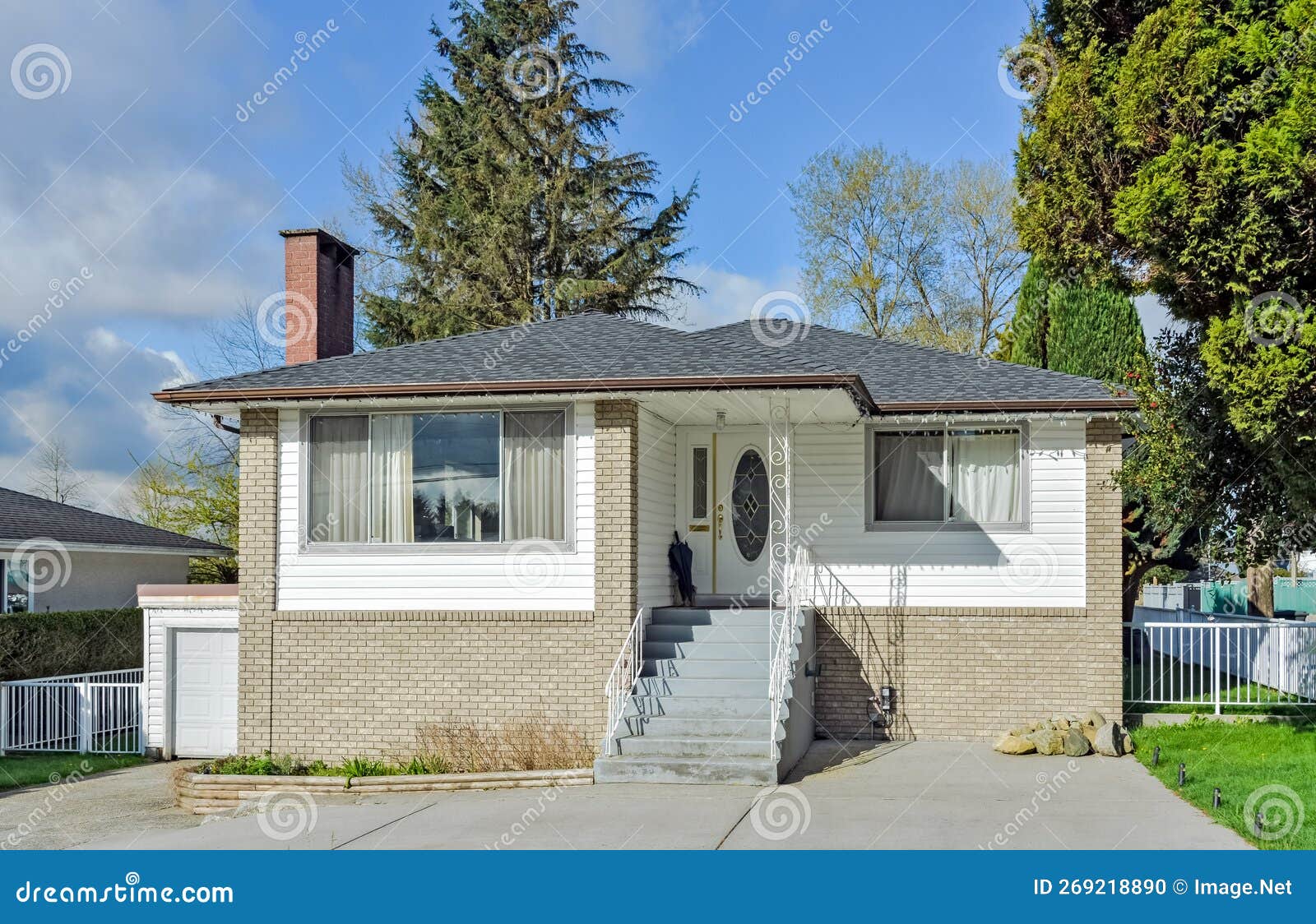 Average Residential House with Concrete Stairs and Paved Front Yard ...