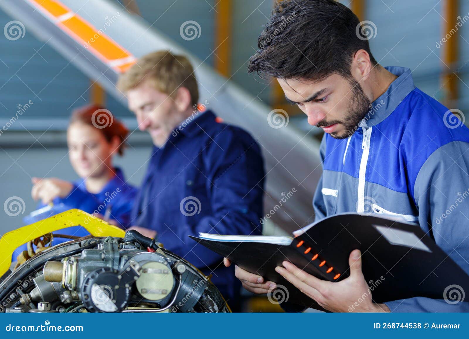 Aviation Engineer Reading Information in Folder Stock Photo - Image of ...