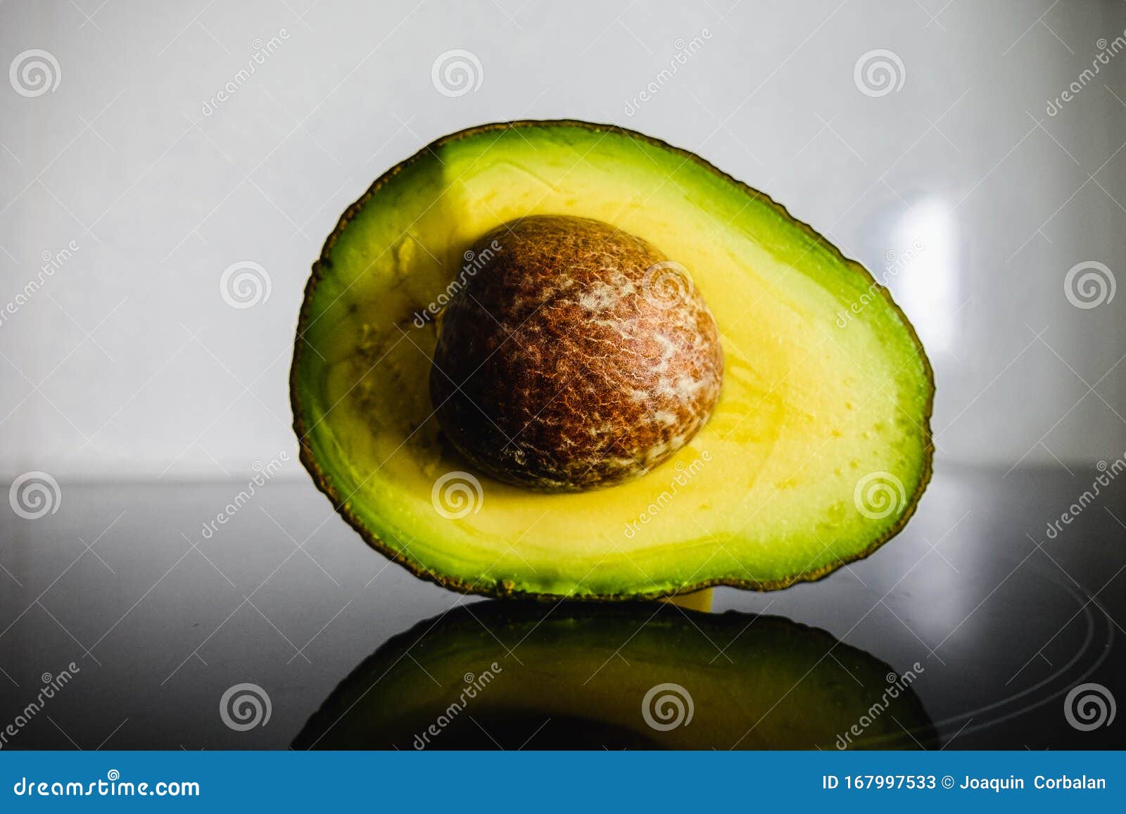Avocado, Cross Section, with Its Reflection in a Black Surface of a ...