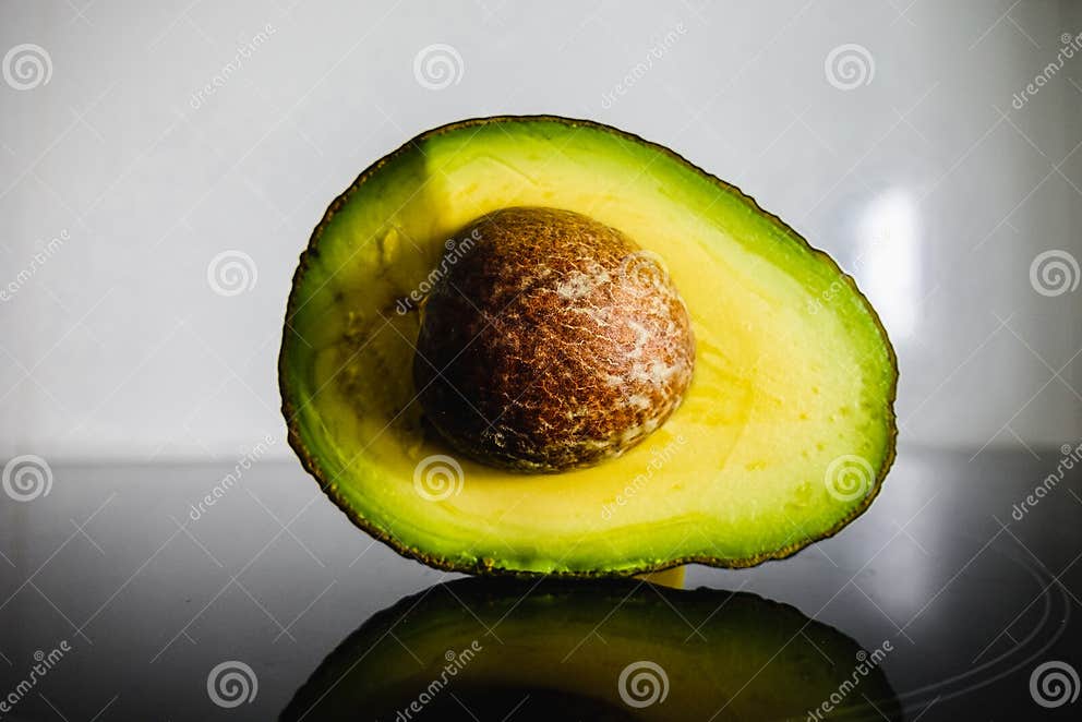 Avocado, Cross Section, with Its Reflection in a Black Surface of a ...