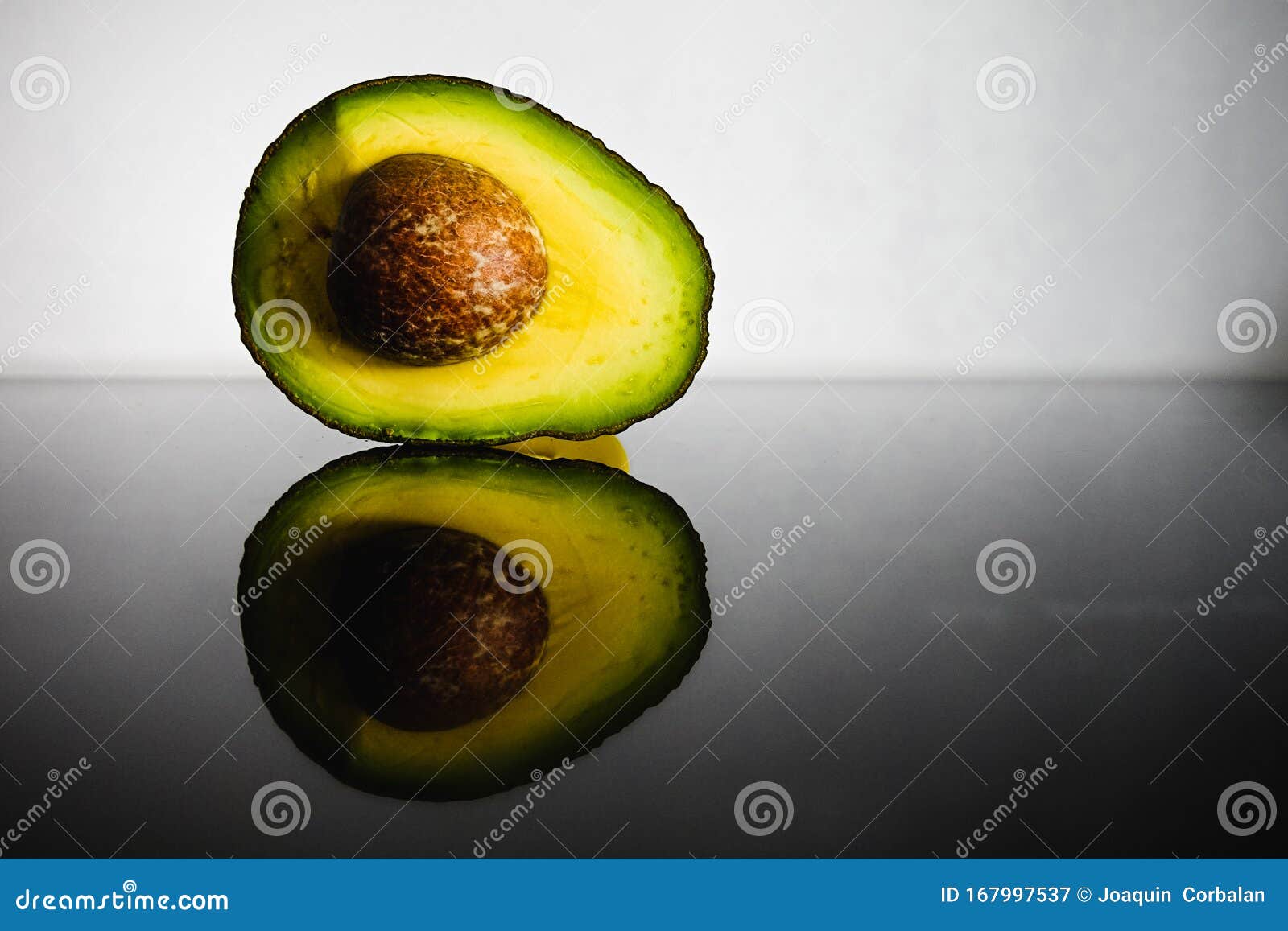 Avocado, Cross Section, with Its Reflection in a Black Surface of a ...