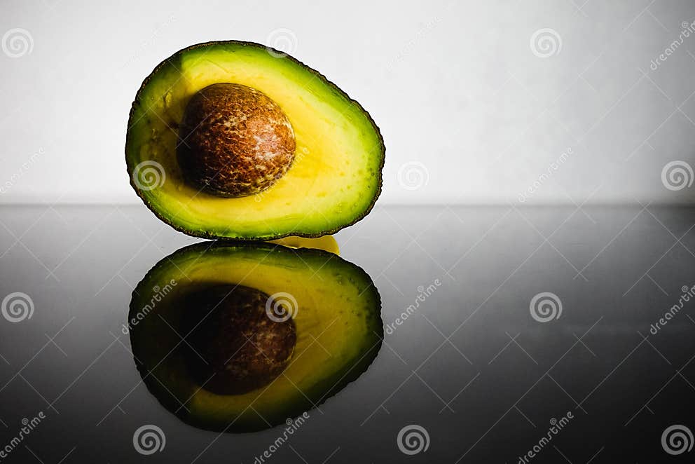 Avocado, Cross Section, with Its Reflection in a Black Surface of a ...