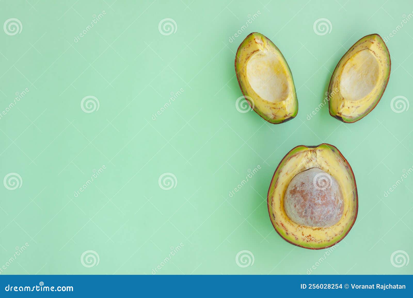 Avocado Cut in Half and Slice on Green Background, Rabbit Shaped of ...