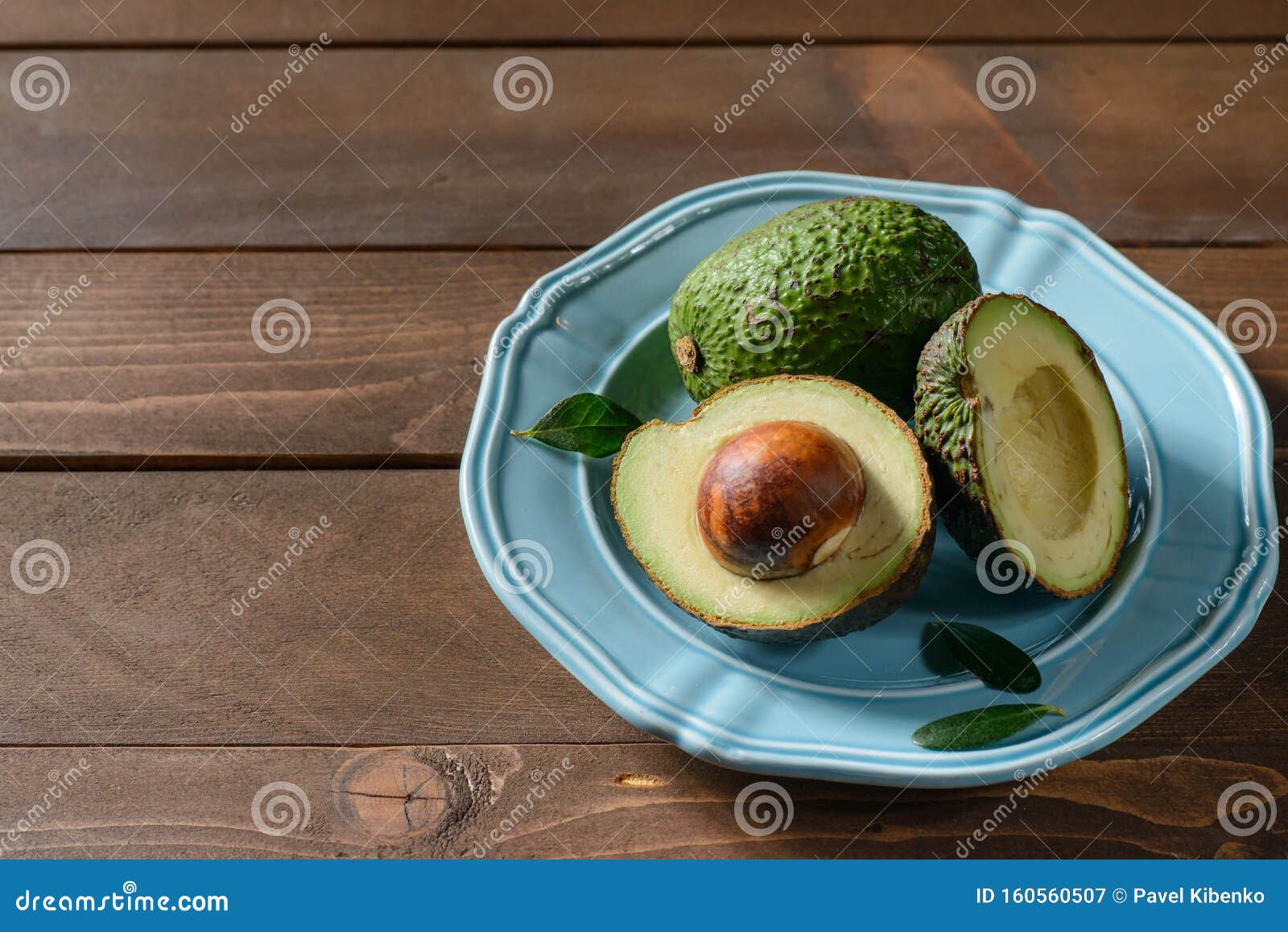Avocado in plate on table stock image. Image of closeup - 160560507
