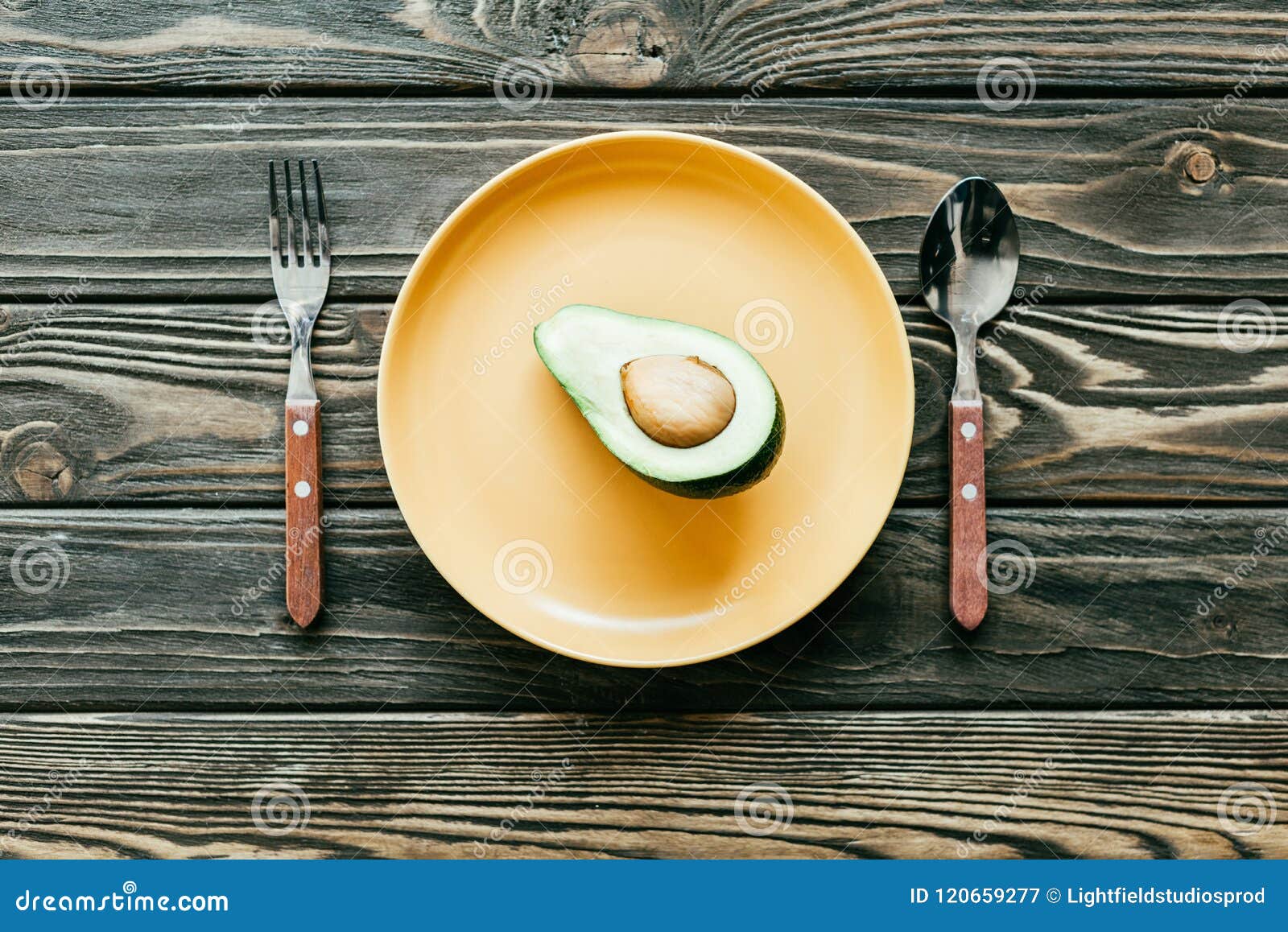 Avocado Served on Plate with Spoon and Fork Stock Image - Image of ...