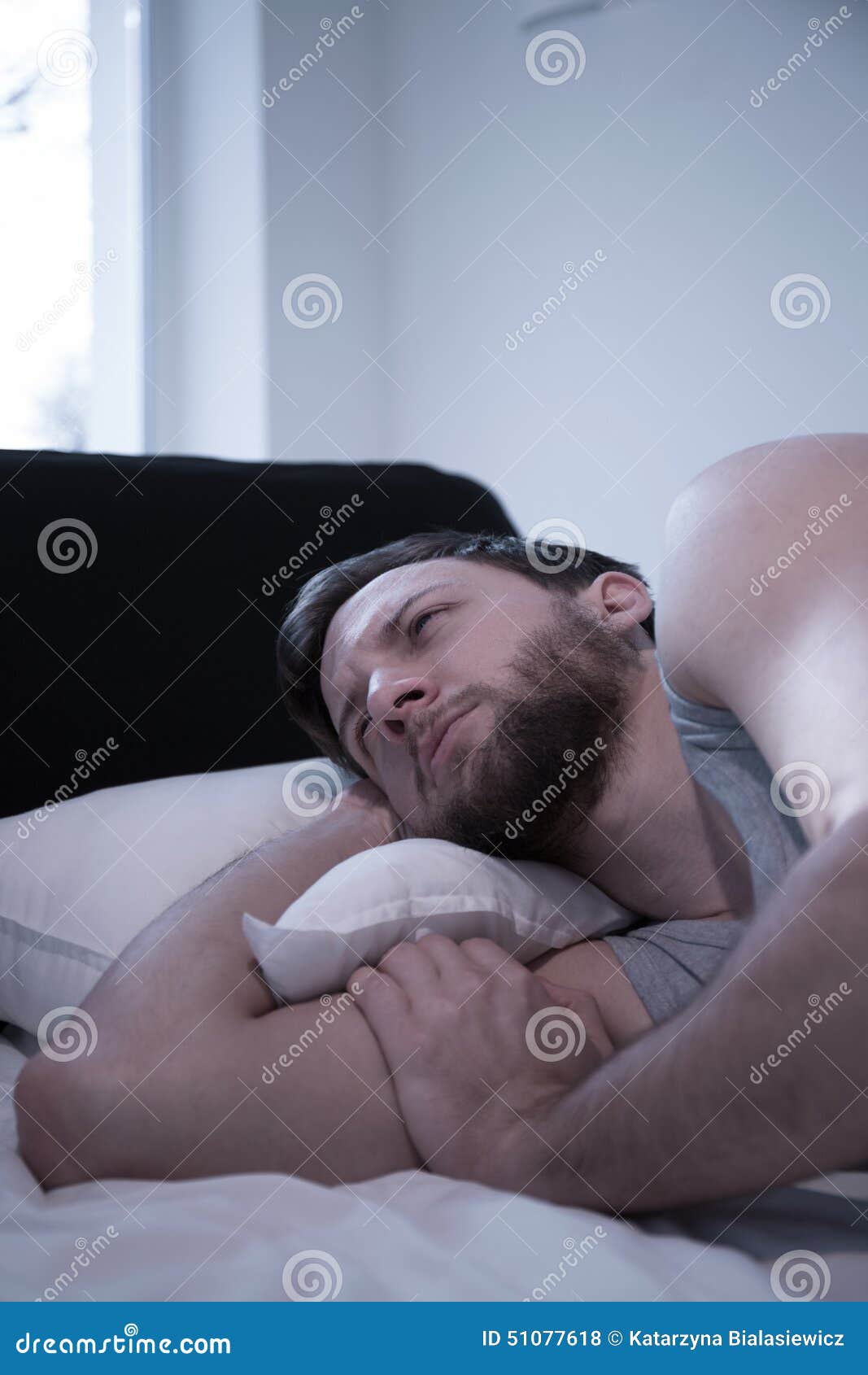 Awake man lying in bed stock photo. Image of pillow, home - 51077618