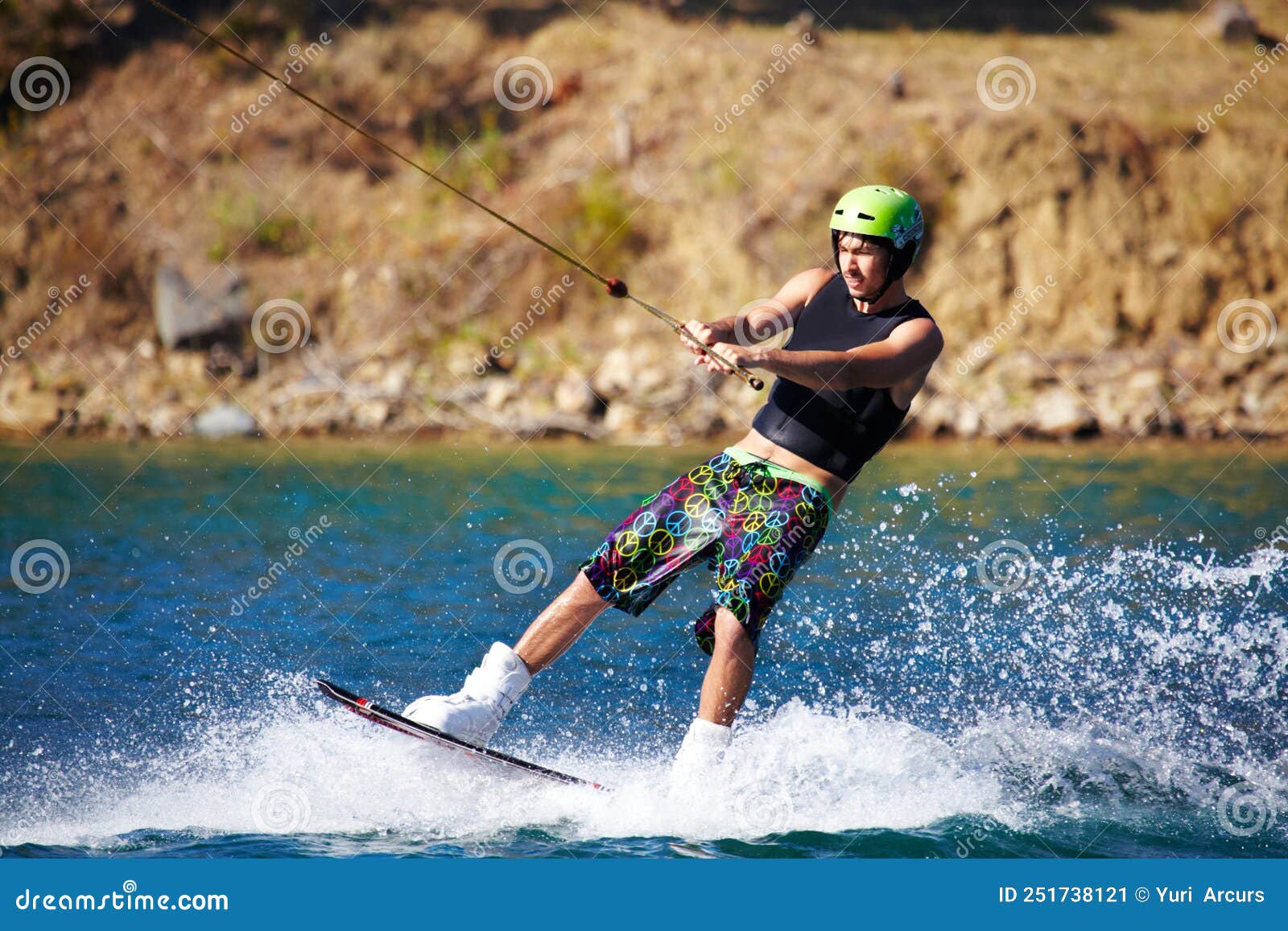Awake on the Wake. Young Wakeboarder Sliding Out on His Back Foot ...