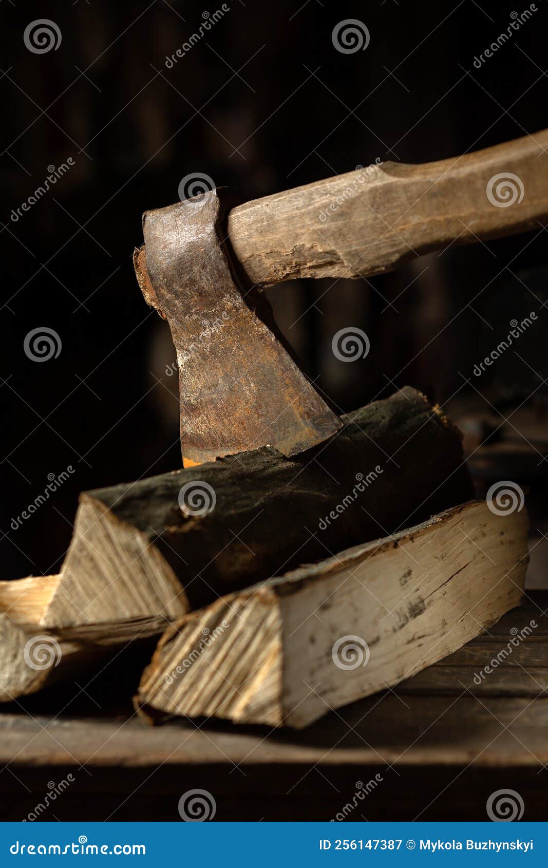 An Ax is Cut into a Log of Firewood for a Firebox on a Wooden Texture ...