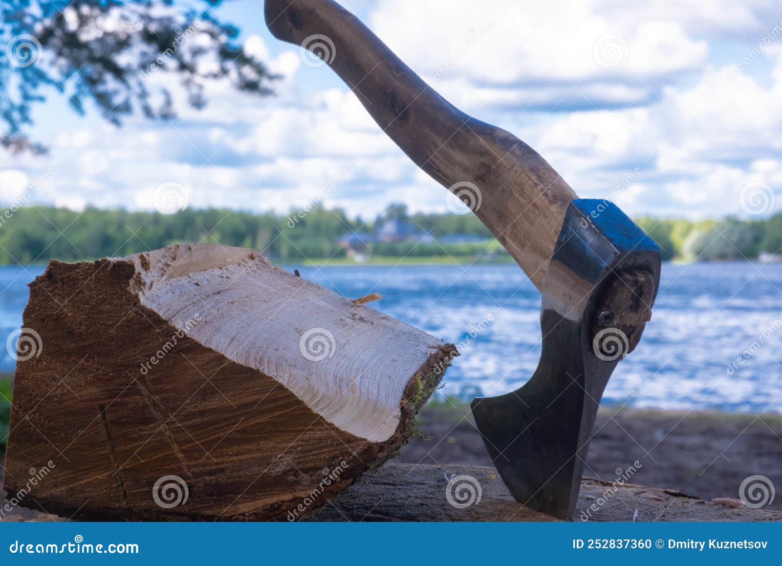 Axe in a Log Against the Background of the River and Clouds Stock Photo ...