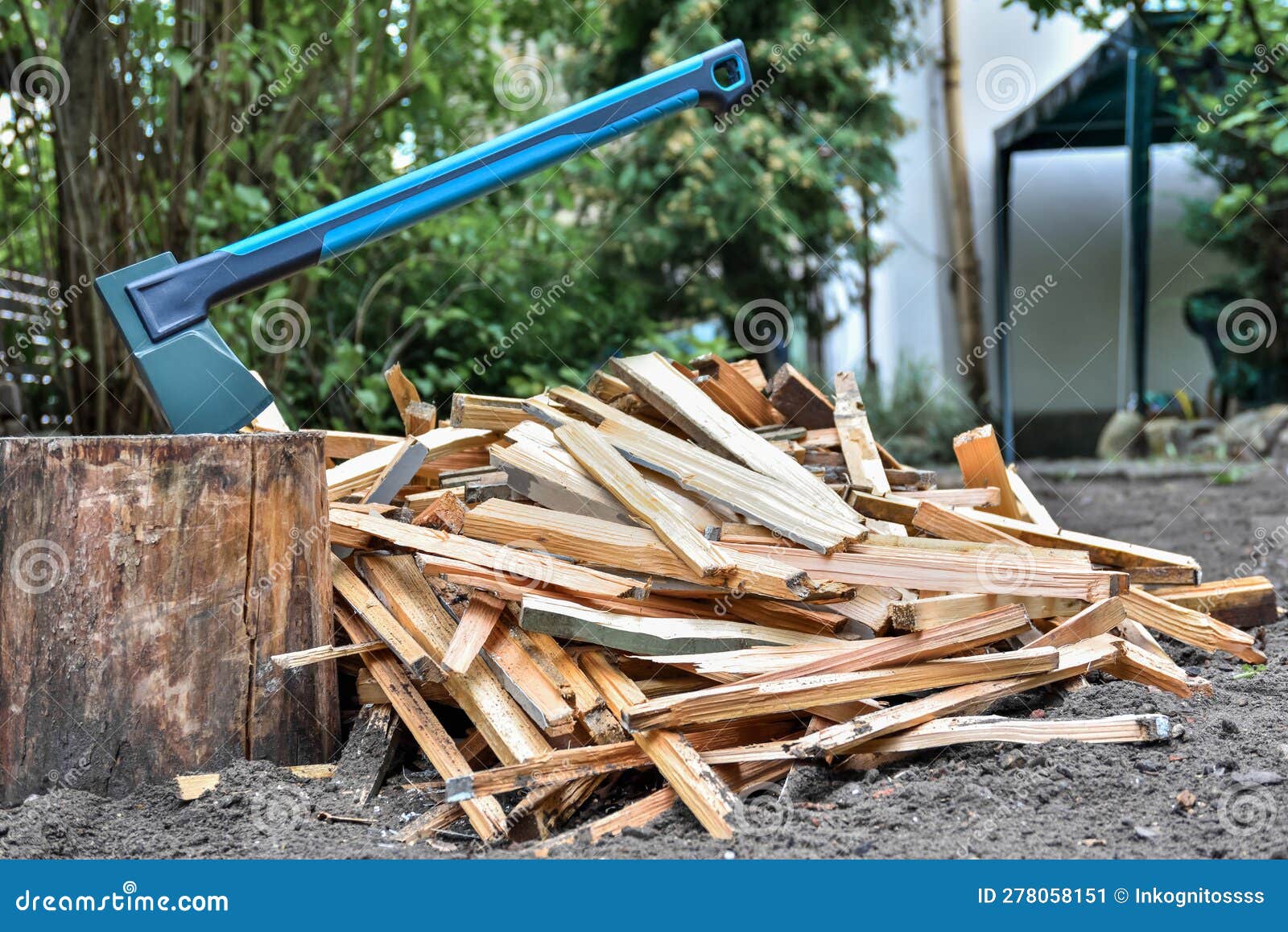 Axe on a Log for Chopping Firewood and a Pile of Chopped Firewood Stock ...