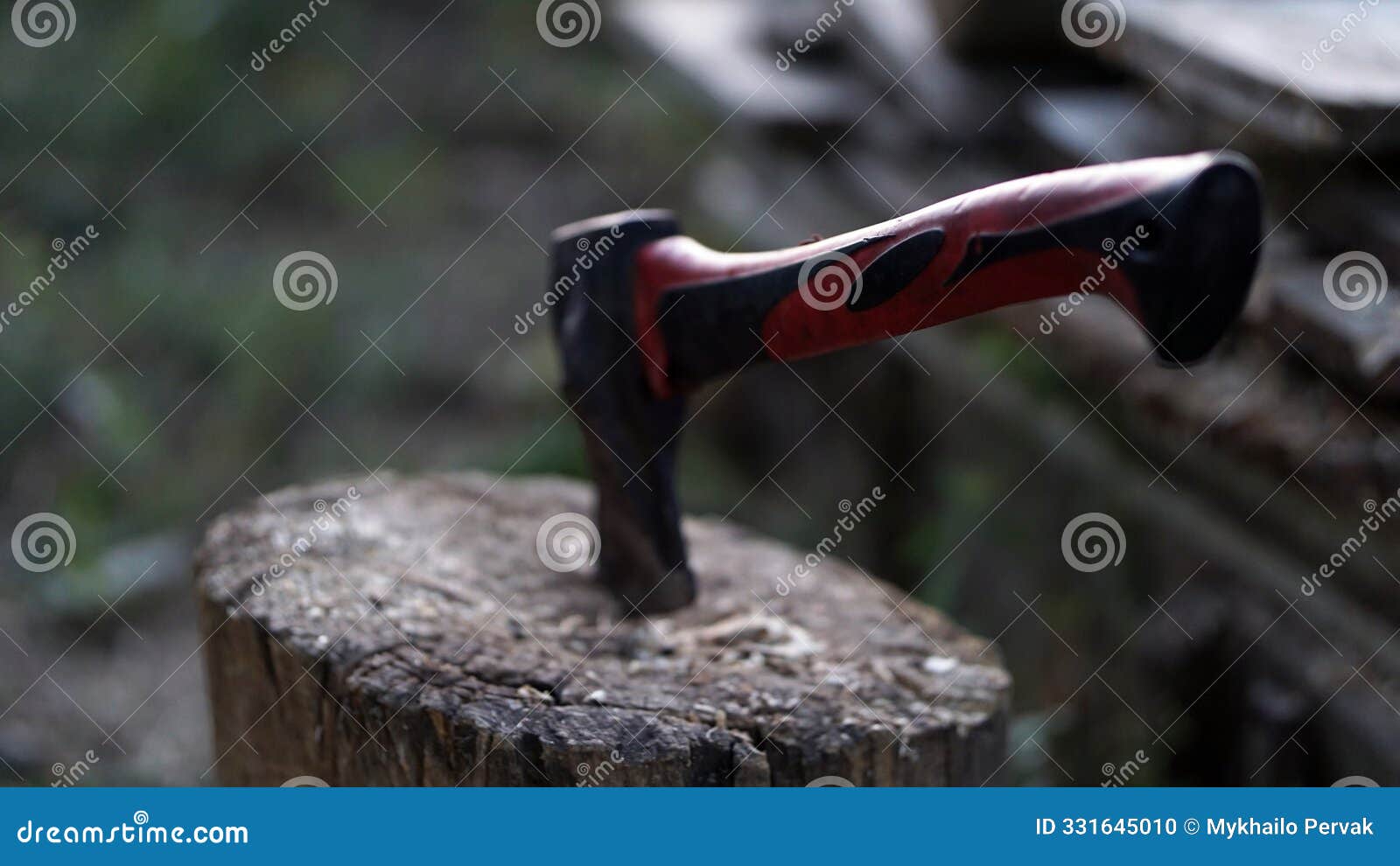 An Axe with a Rubber Handle is Stuck in a Wooden Log. Logging on the ...