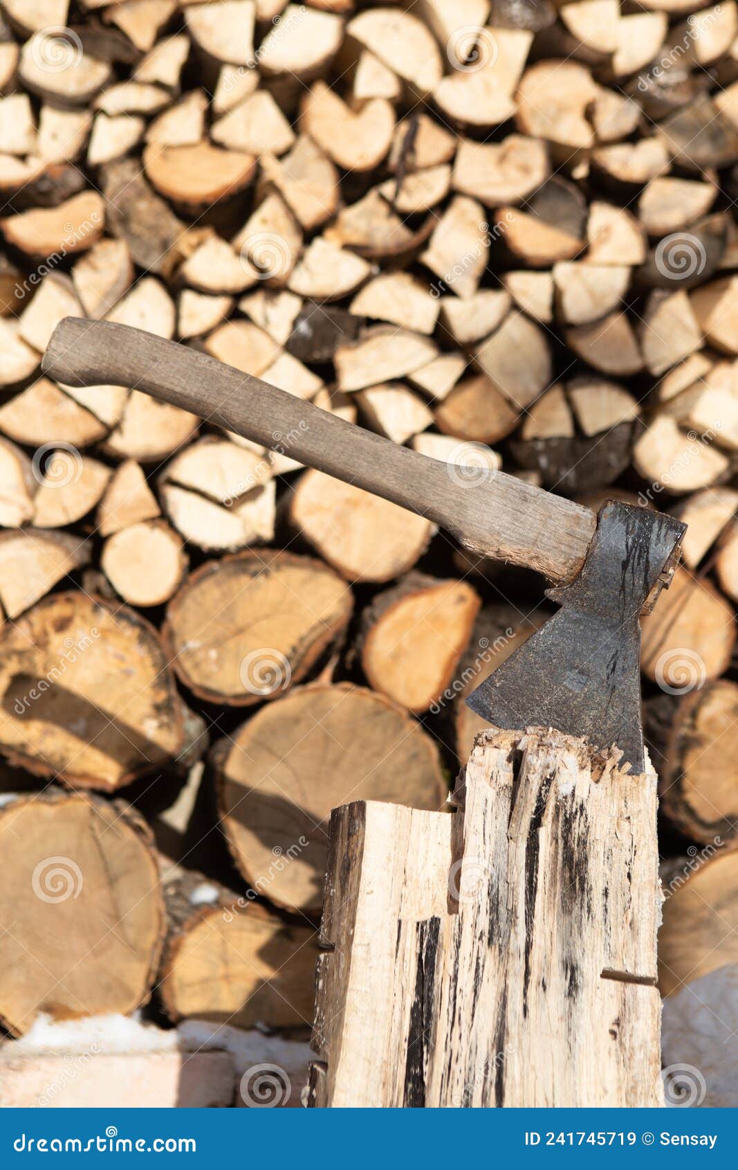 Axe Set in Chopping Block in Front of a Woodpile Background Stock Image ...
