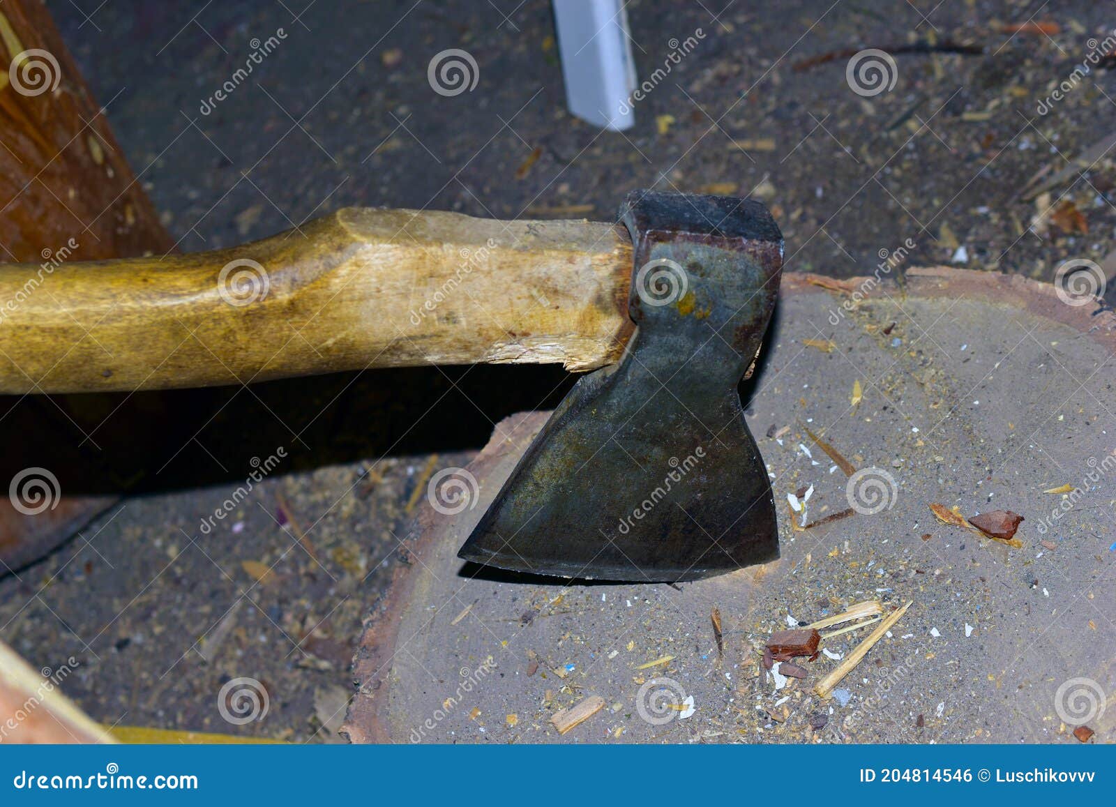 An Axe Stuck in a Tree Stump in a Barn Stock Photo - Image of ...