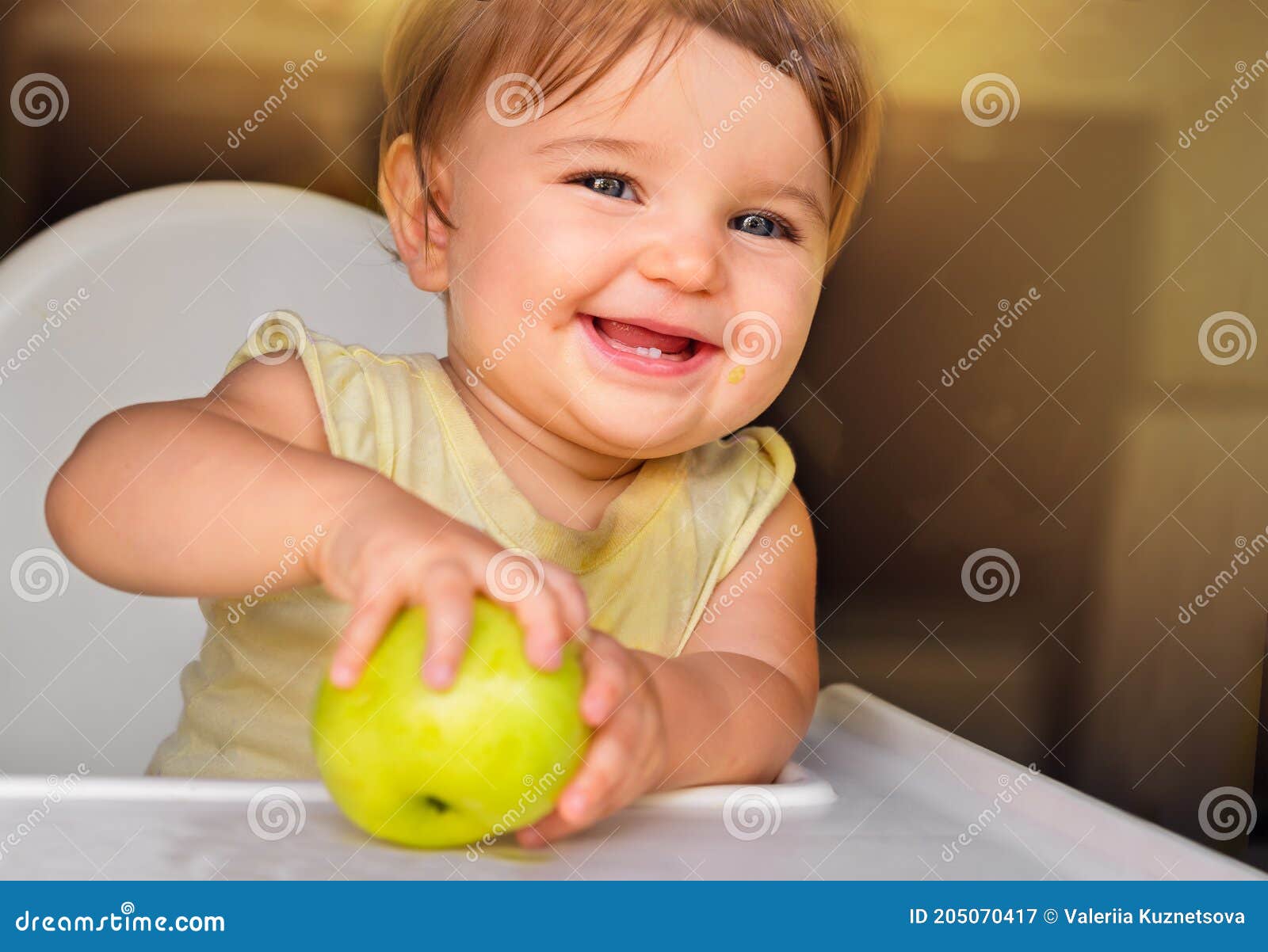 Baby with an apple stock image. Image of face, lifestyle - 205070417