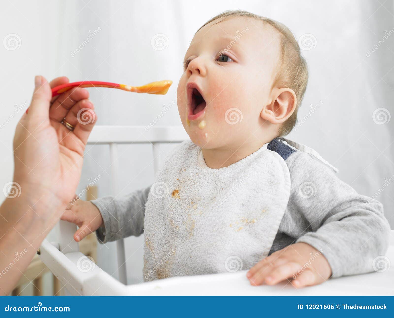 Baby Being Fed stock photo. Image of camera, food, chair - 12021606