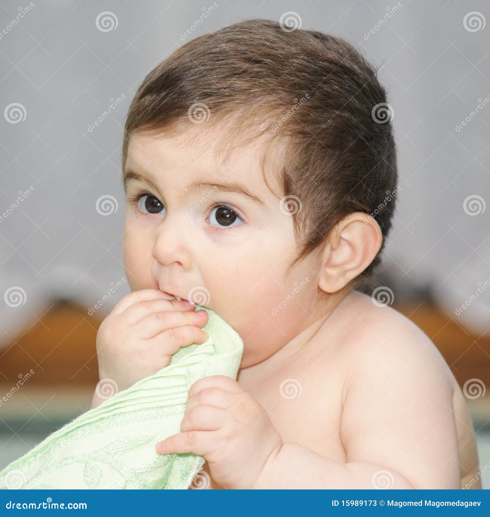 Baby biting green towel stock image. Image of person - 15989173