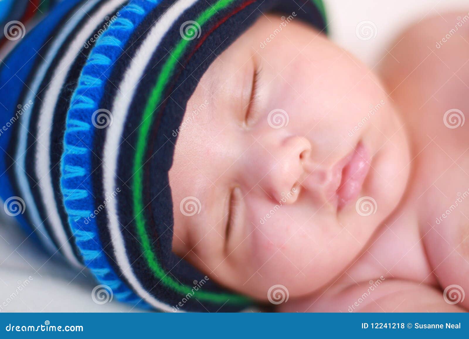 Baby in blue cap sleeping stock photo. Image of sweet - 12241218