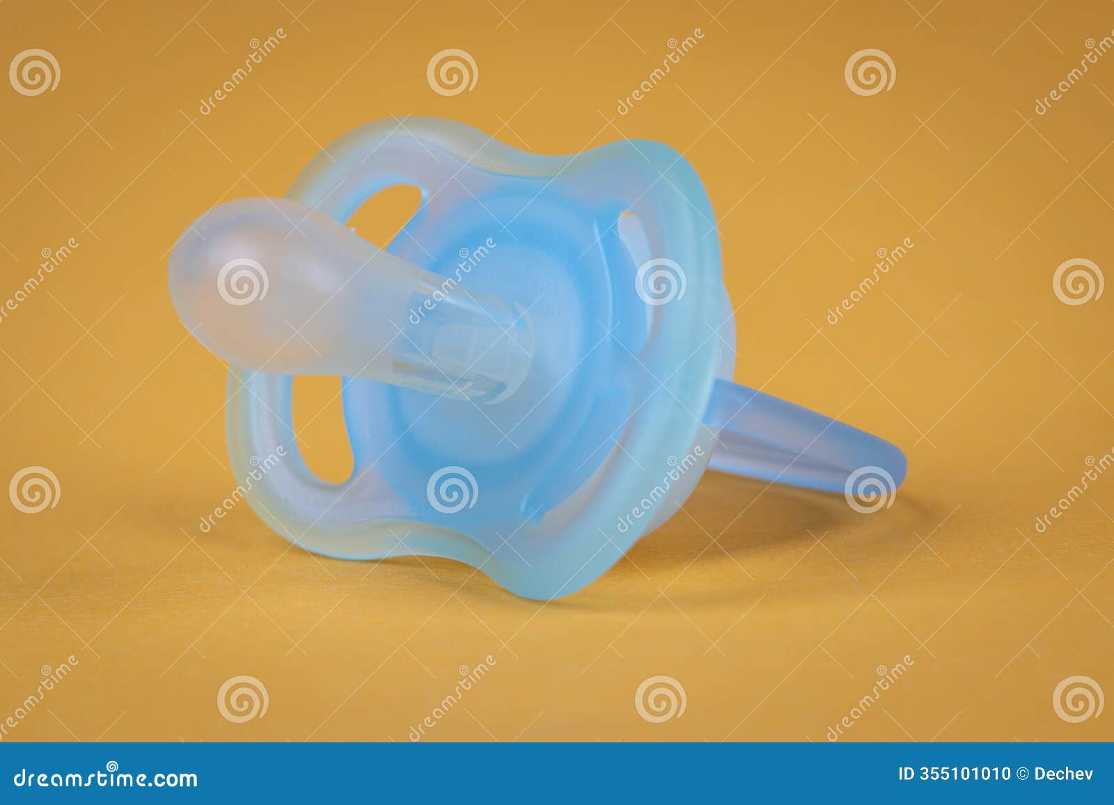 Baby Blue Pacifier on a Yellow Background Stock Photo - Image of rubber ...