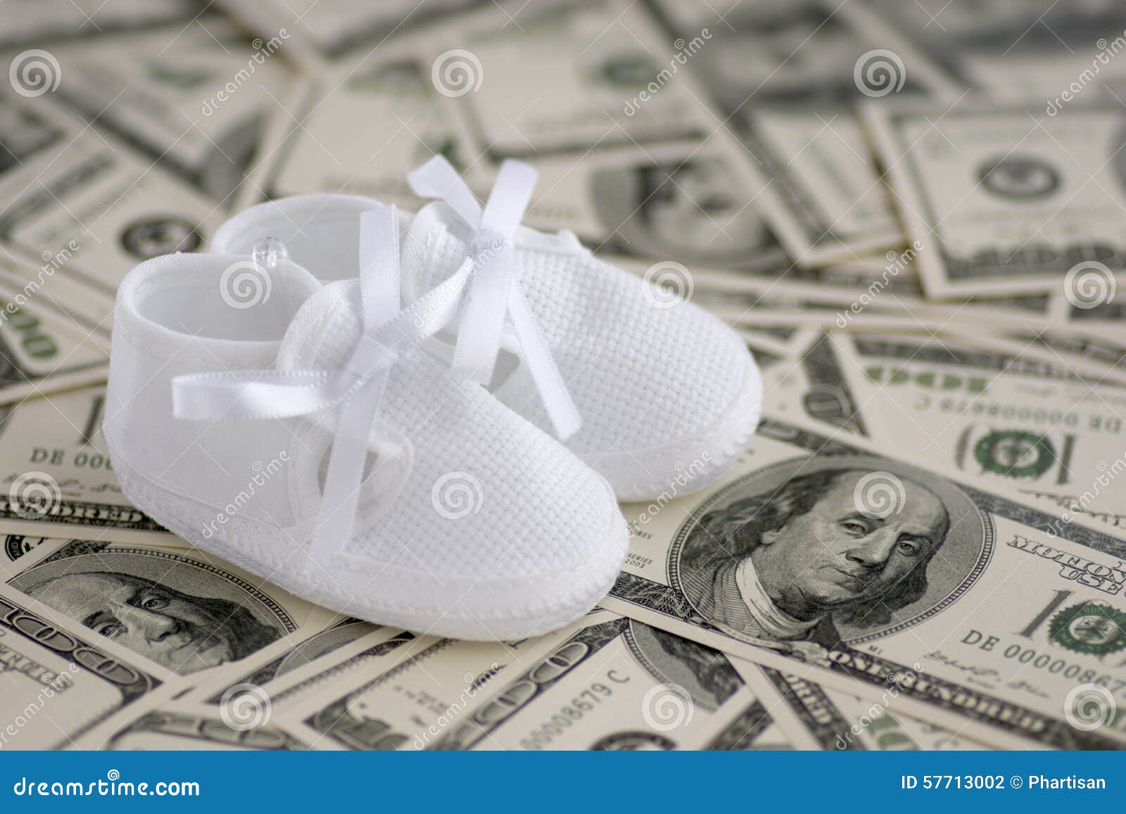 Baby boots on money stock photo. Image of budget, debt - 57713002