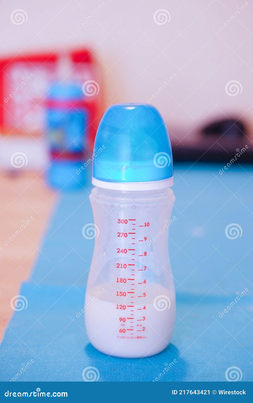 Baby bottle on a table stock image. Image of plastic - 217643421