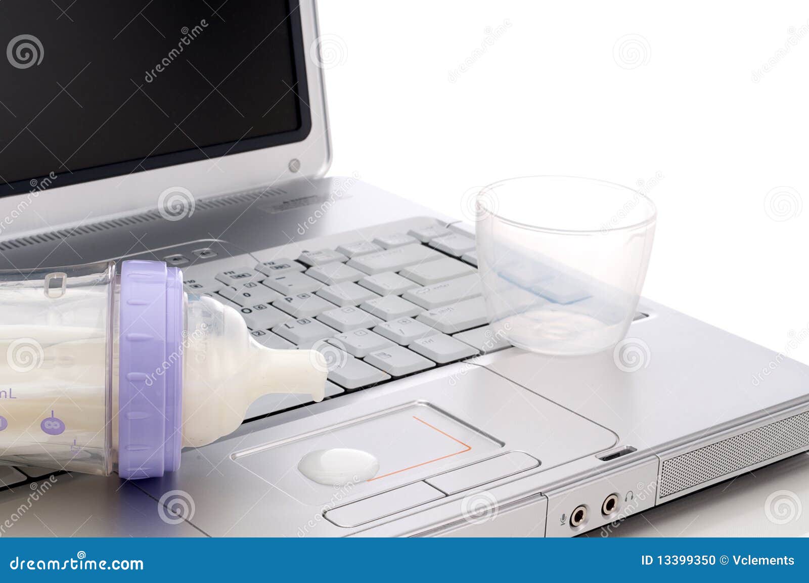 A Baby Bottle Spilling on a Notebook Computer Stock Photo - Image of ...