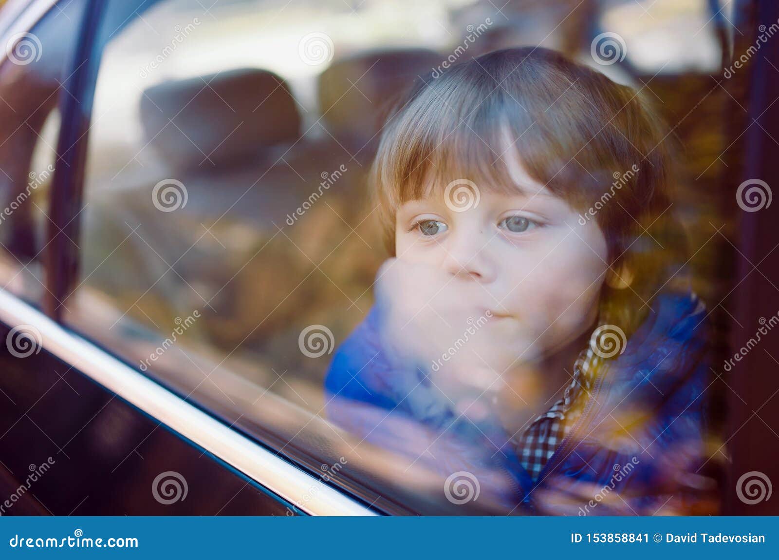 Baby Boy in the Black Car with Beige Interior. Stock Image - Image of ...