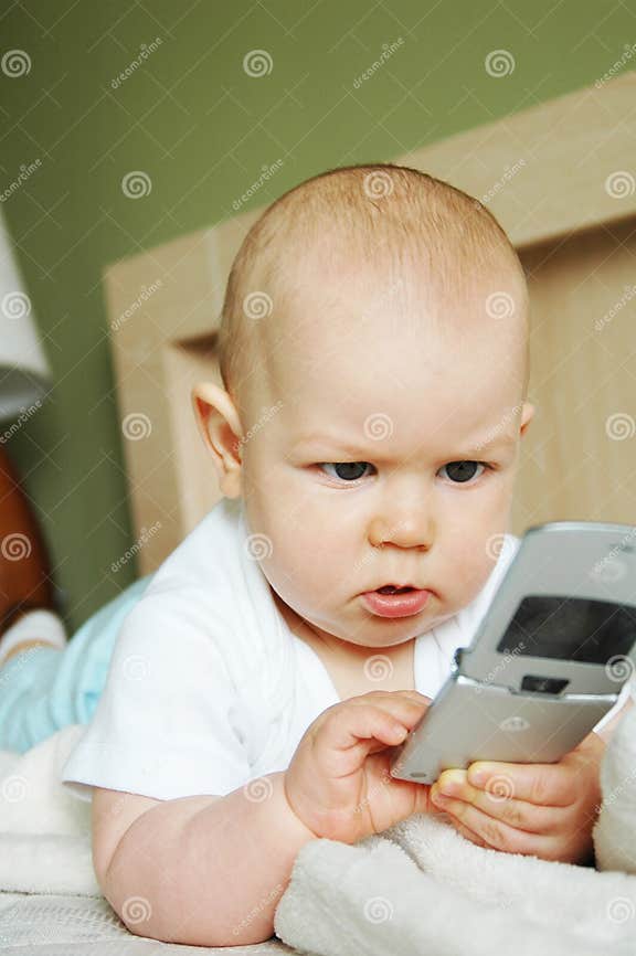 Baby boy with a cellphone stock image. Image of cute, baby - 6044137