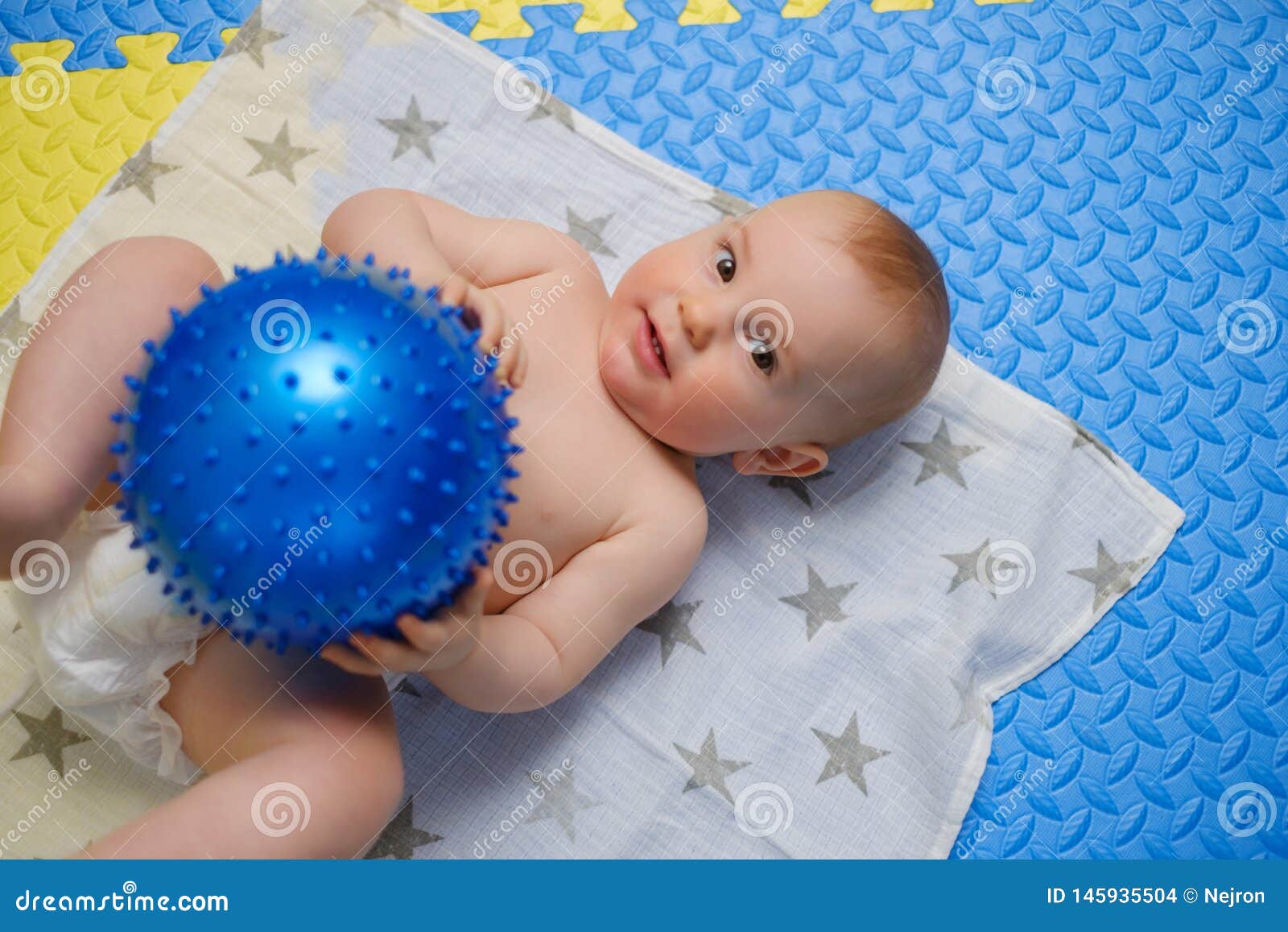 Baby Boy Getting Massage with Special Equipment Stock Photo - Image of ...