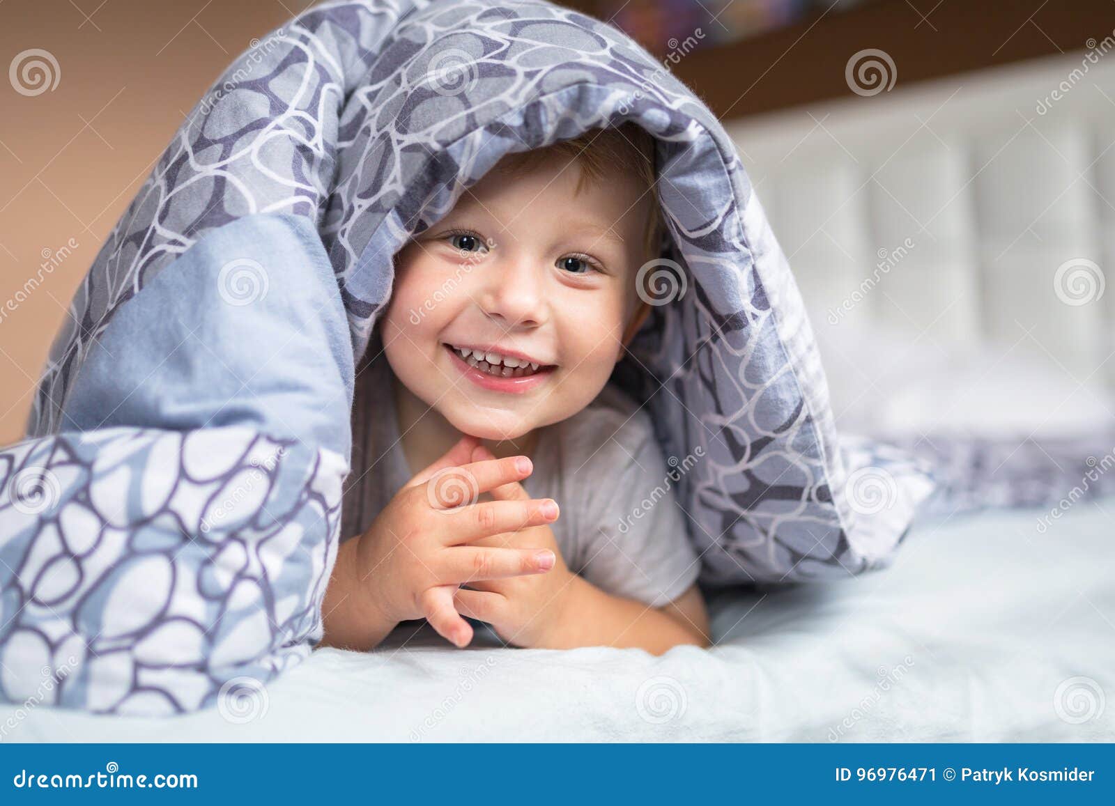Baby boy hiding in bed stock image. Image of parents - 96976471