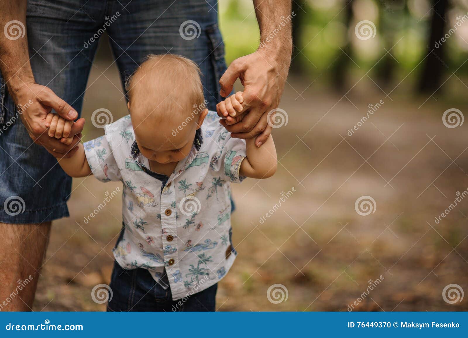 Baby Boy Learning To Walk and Making His First Steps Holding Hands of ...
