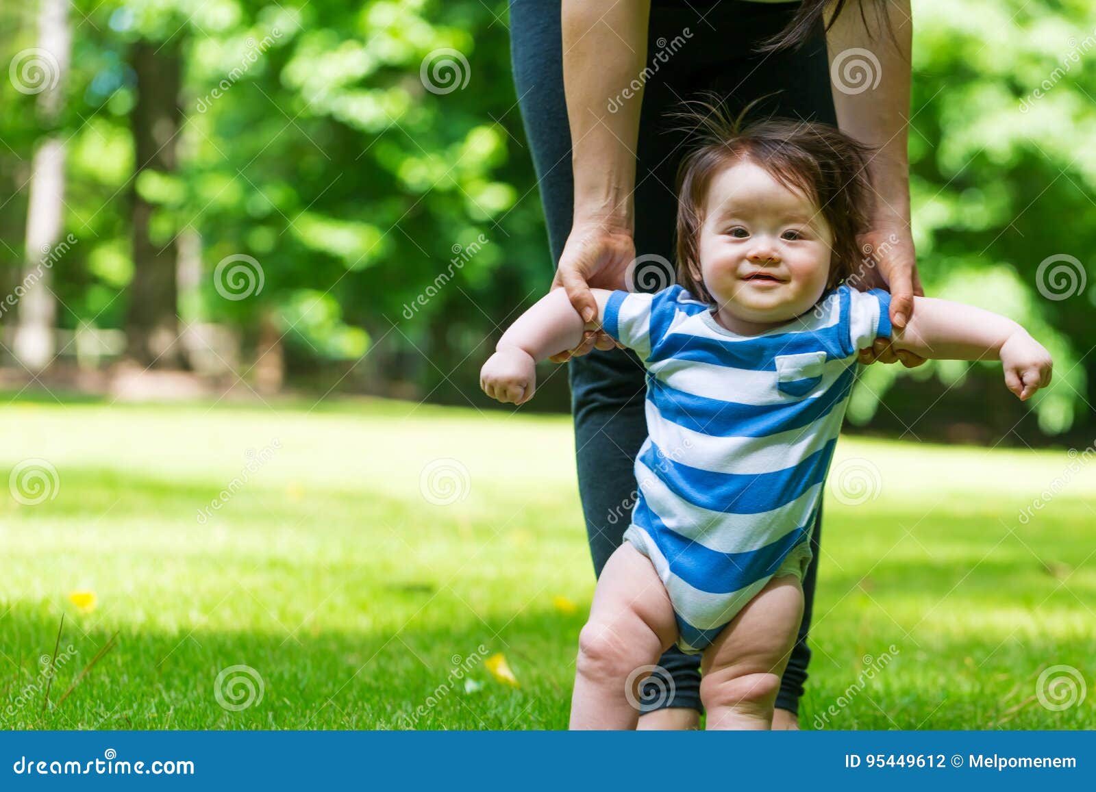 Baby Boy Learning To Walk Outside Stock Photo - Image of help, parent ...