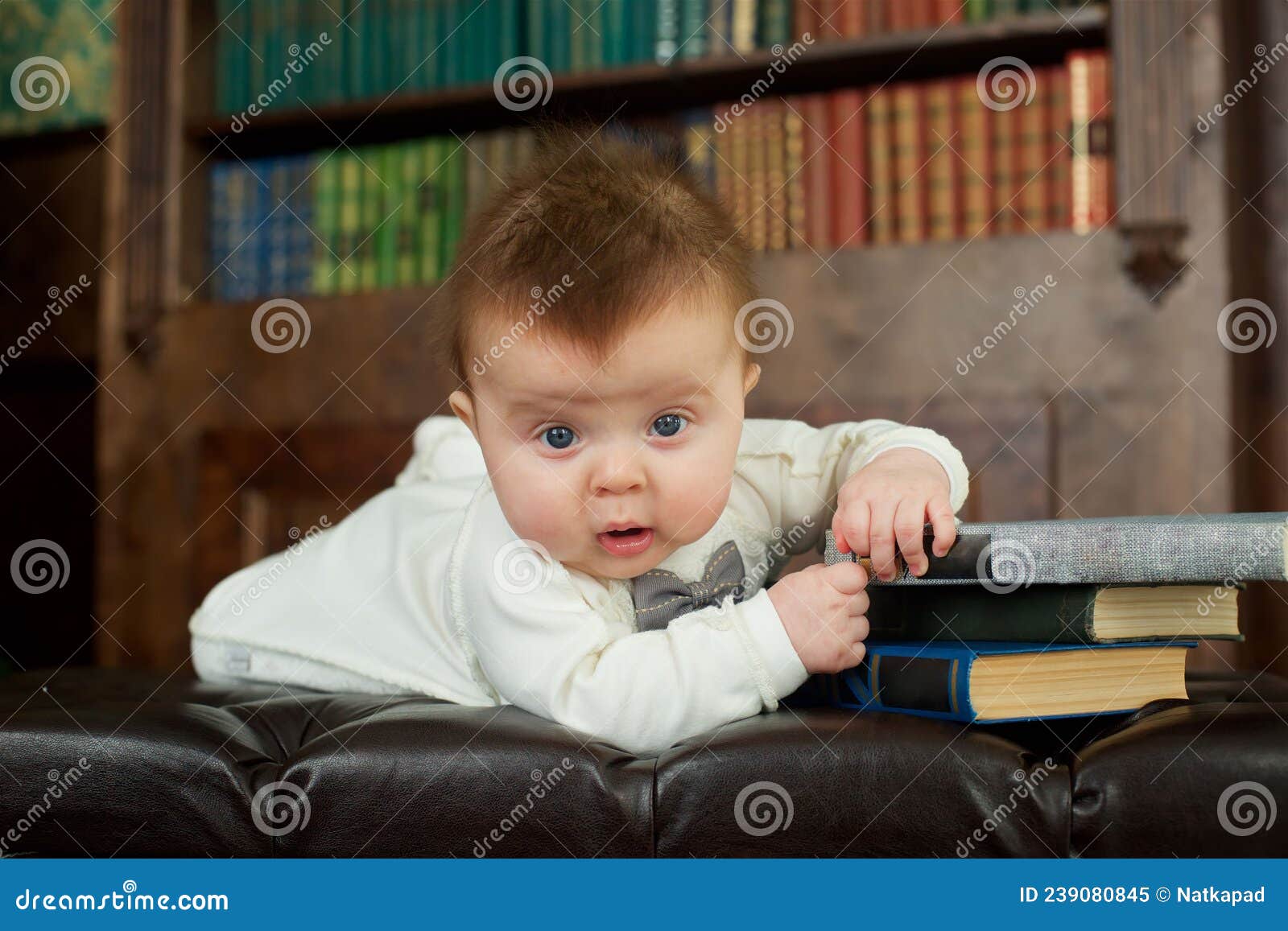 A Baby Boy is Lying on a Soft Surface. Under the Child`s Hands is a ...