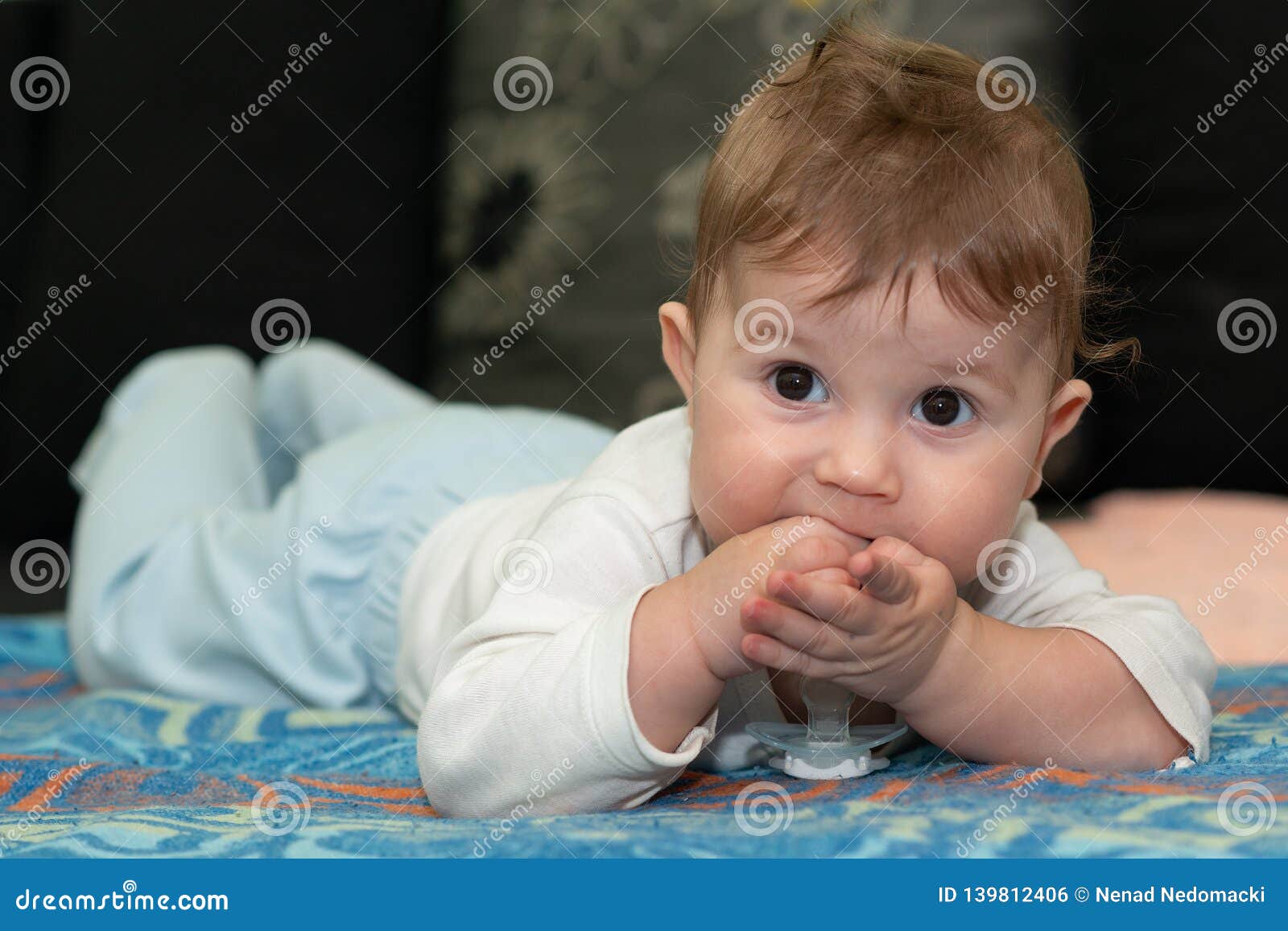 Baby Boy is Lying on Tummy. the Baby Boy Poses and Plays with a ...
