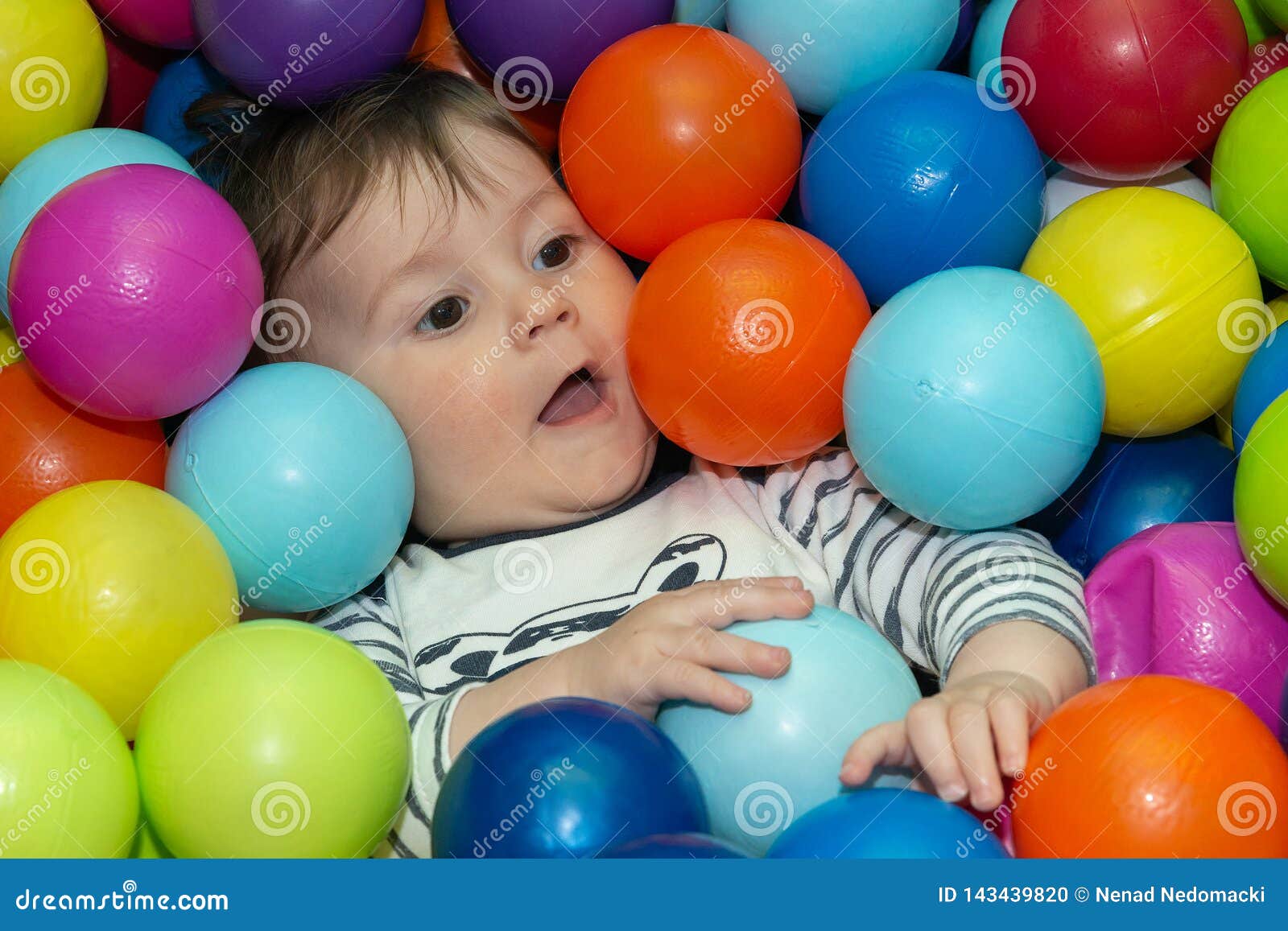The Baby Boy is Playing with Color Balls Stock Photo - Image of ...
