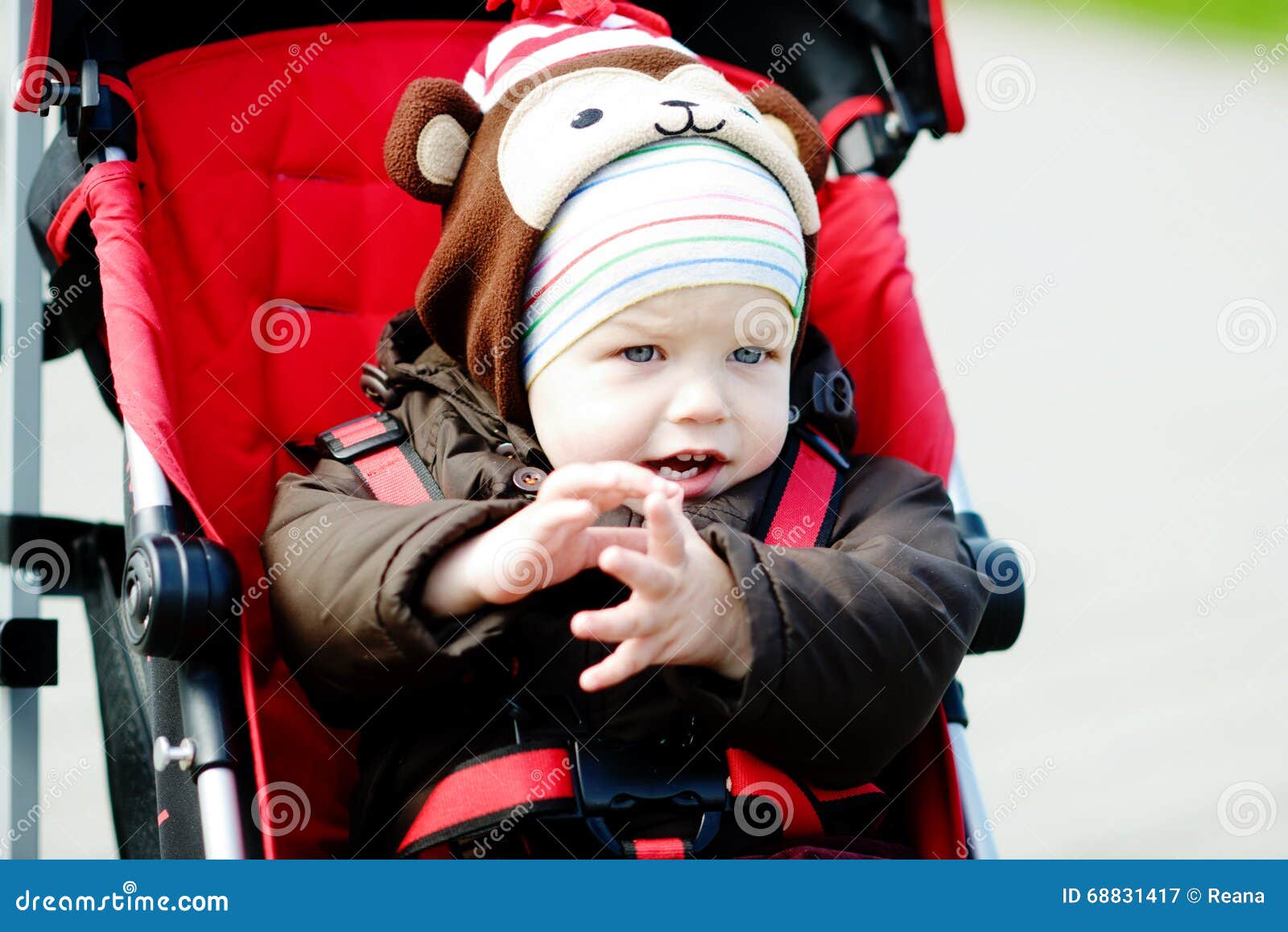 Baby boy in red stroller stock image. Image of face, lovely - 68831417
