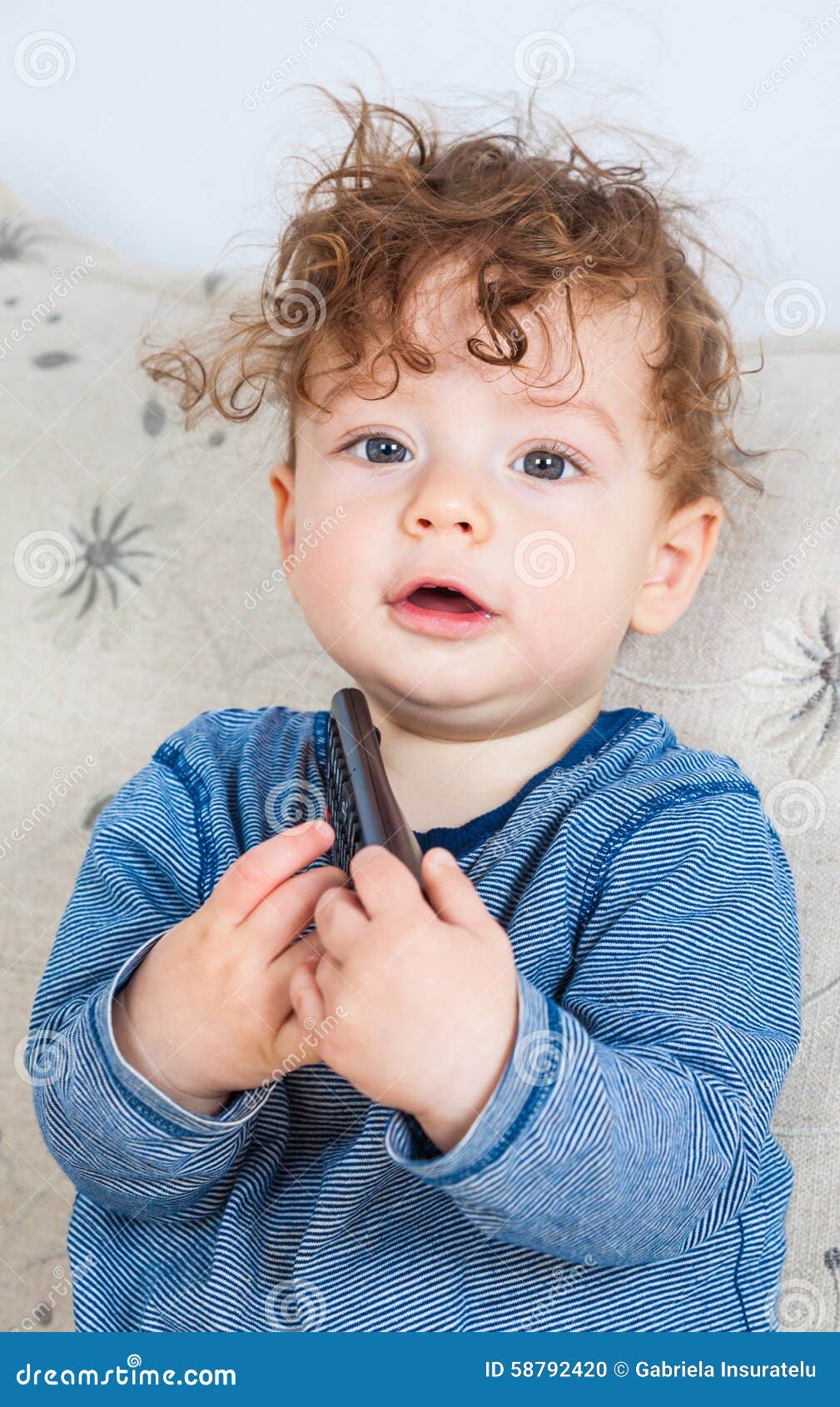 Baby boy with remote stock photo. Image of child, remote - 58792420