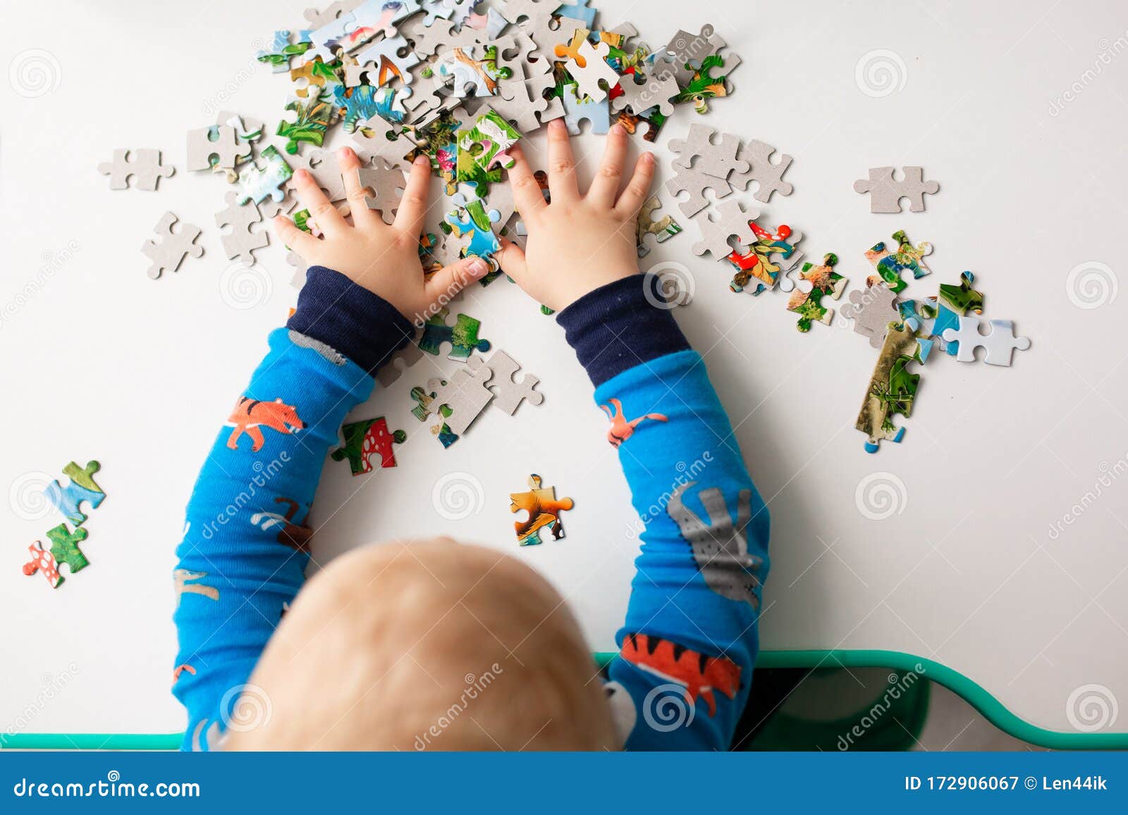 Baby Boy Solving Jigsaw Puzzle on the Desk Stock Image - Image of ...