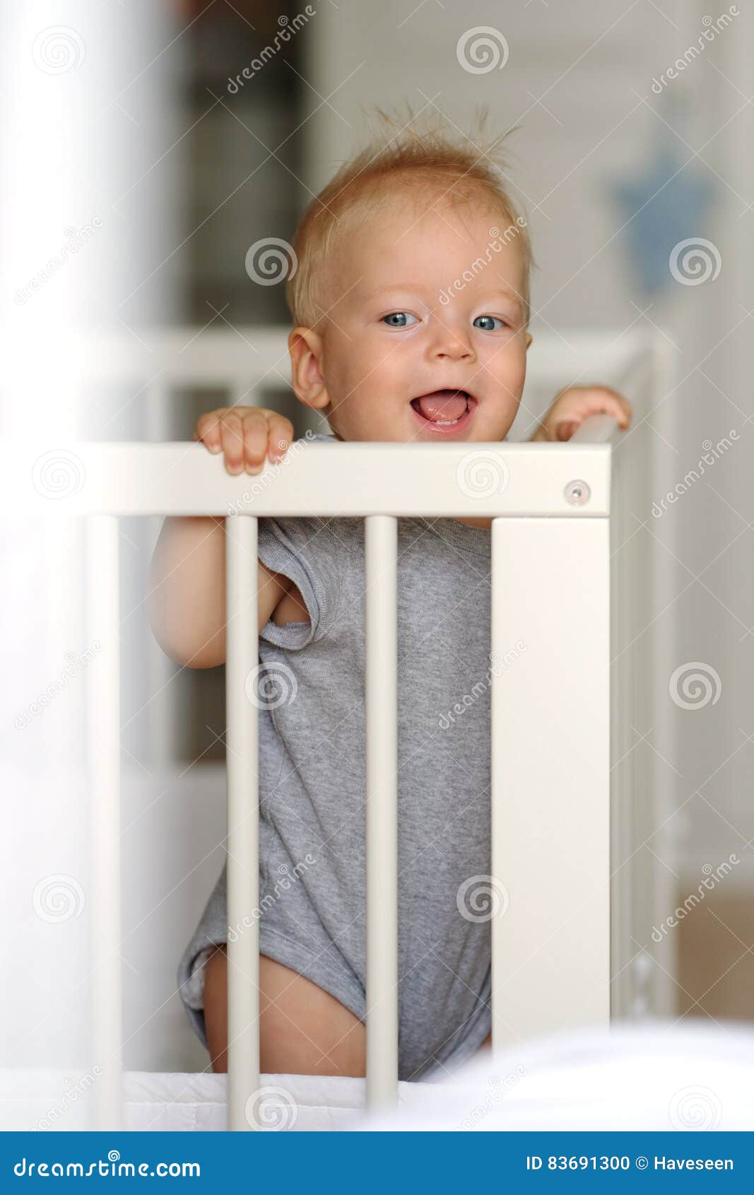 Baby boy standing in crib stock photo. Image of human - 83691300