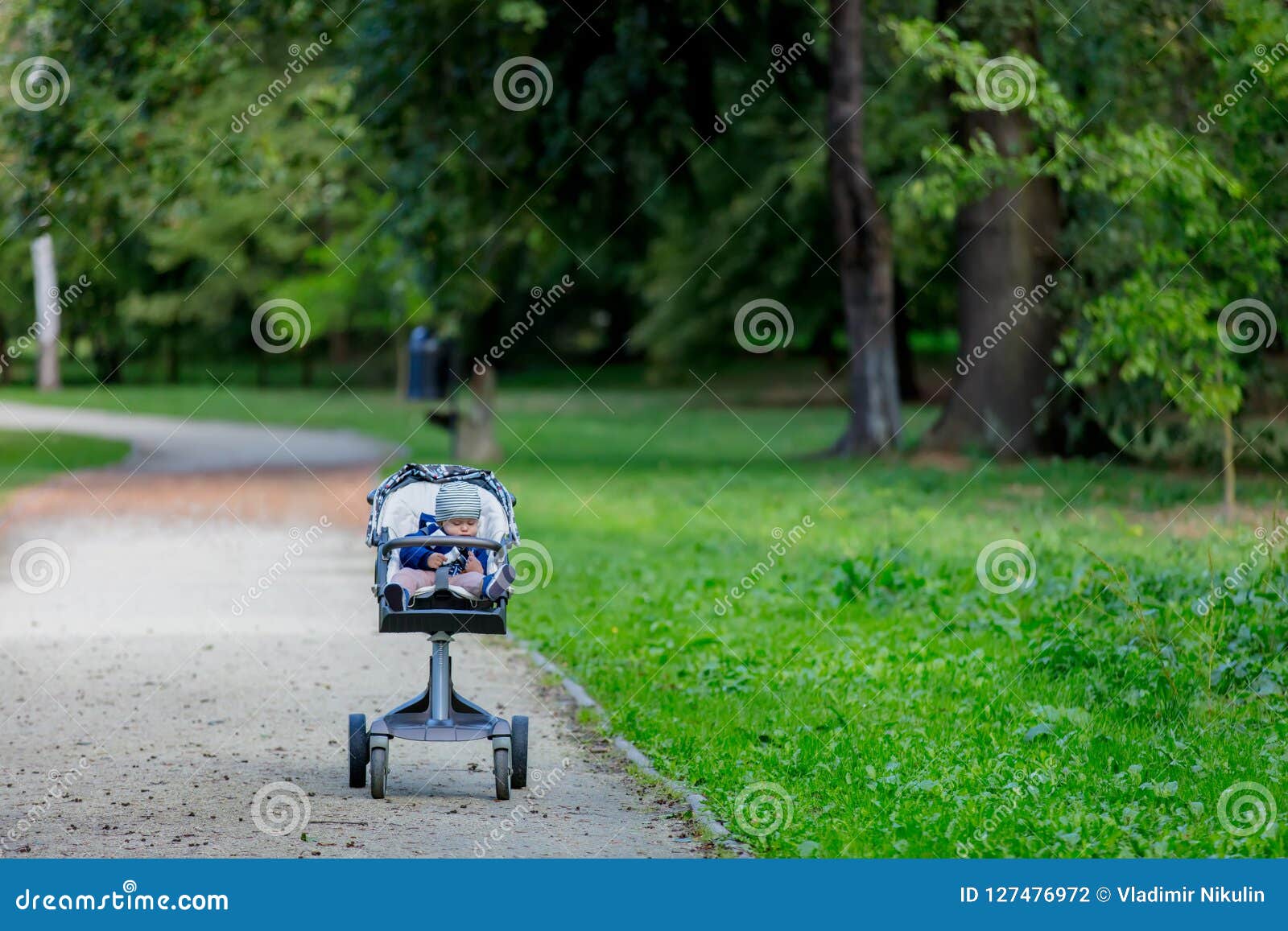 Baby Boy in a Stroller in a Park. Stock Photo - Image of eyes, violet ...