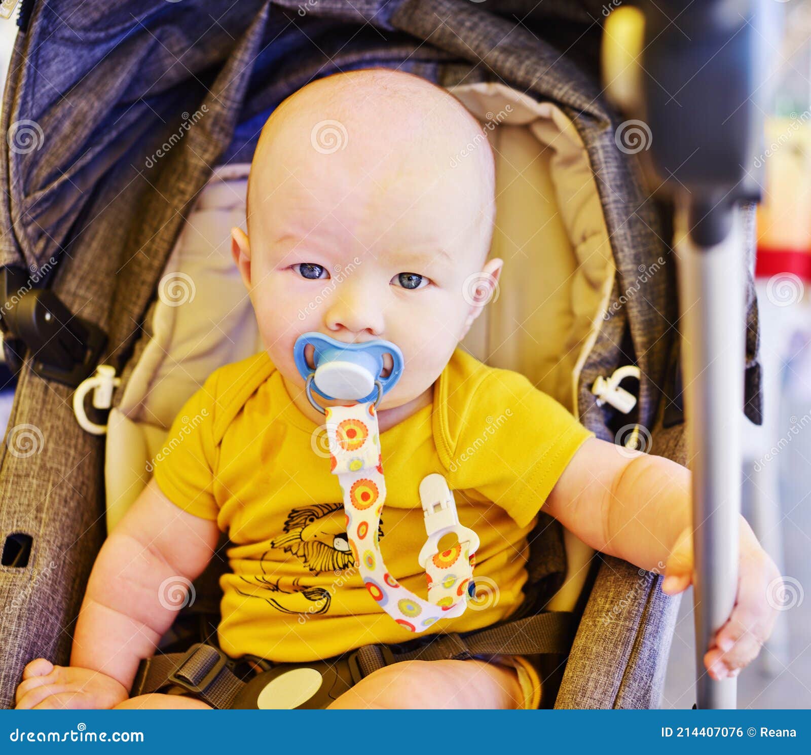 Baby boy in stroller stock photo. Image of outdoors - 214407076